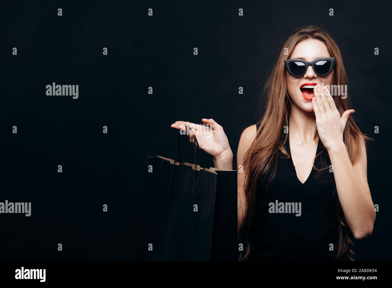 Young pretty female boutique customer showing surprise emotions ...