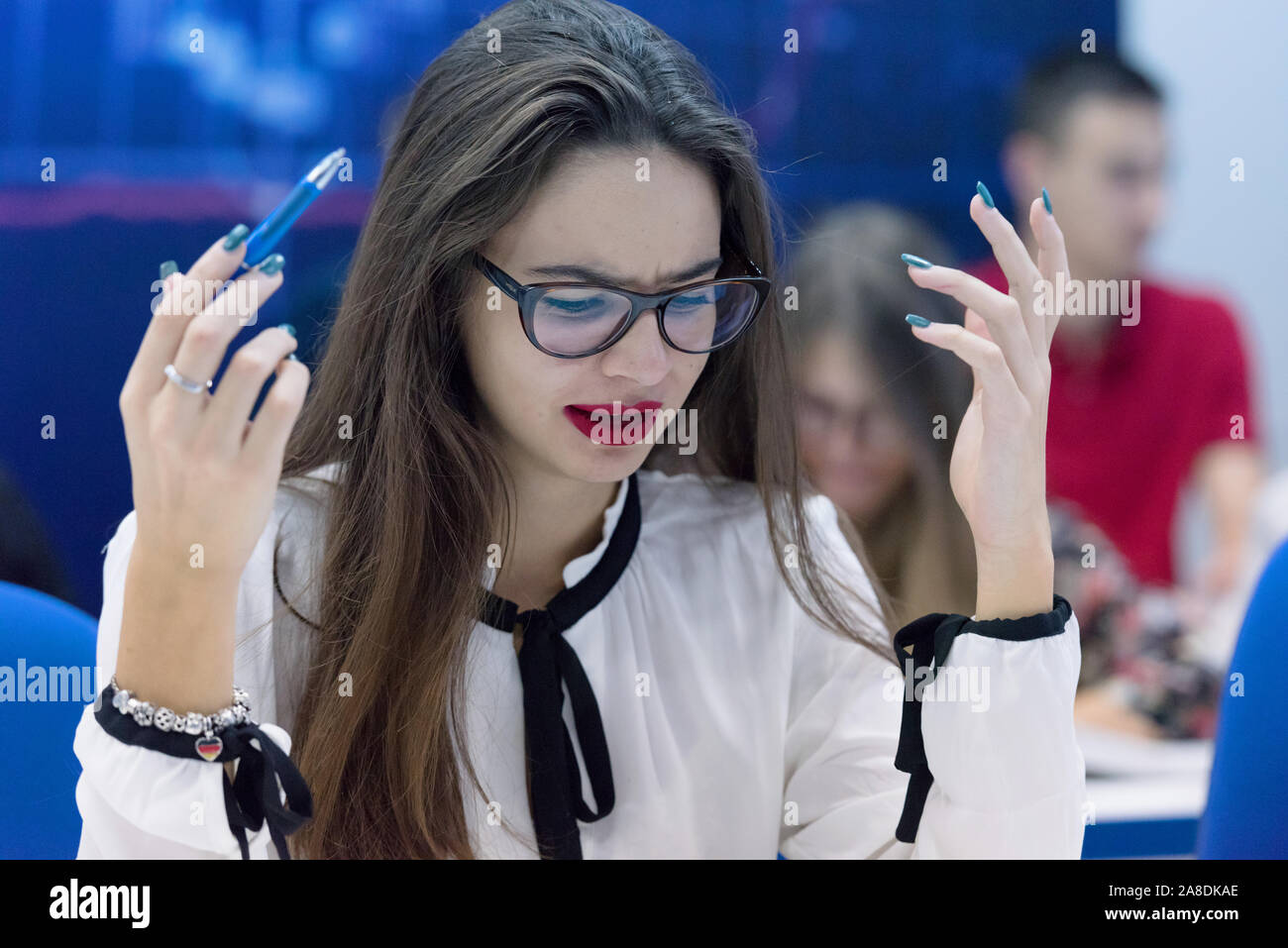 Young female student in math class overwhelmed by the math formula ...