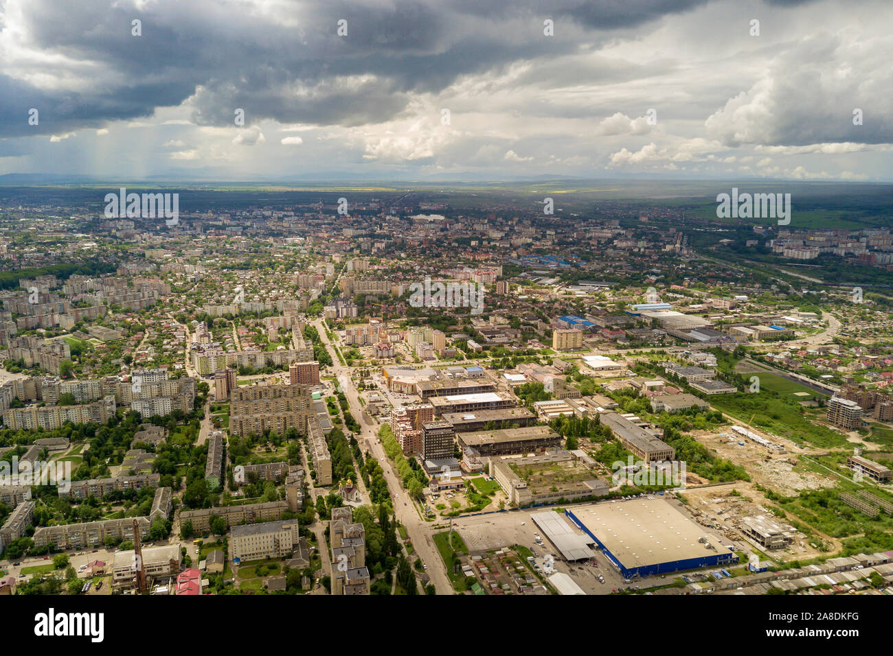 Aerial view of town or city with rows of buildings and curvy streets in ...