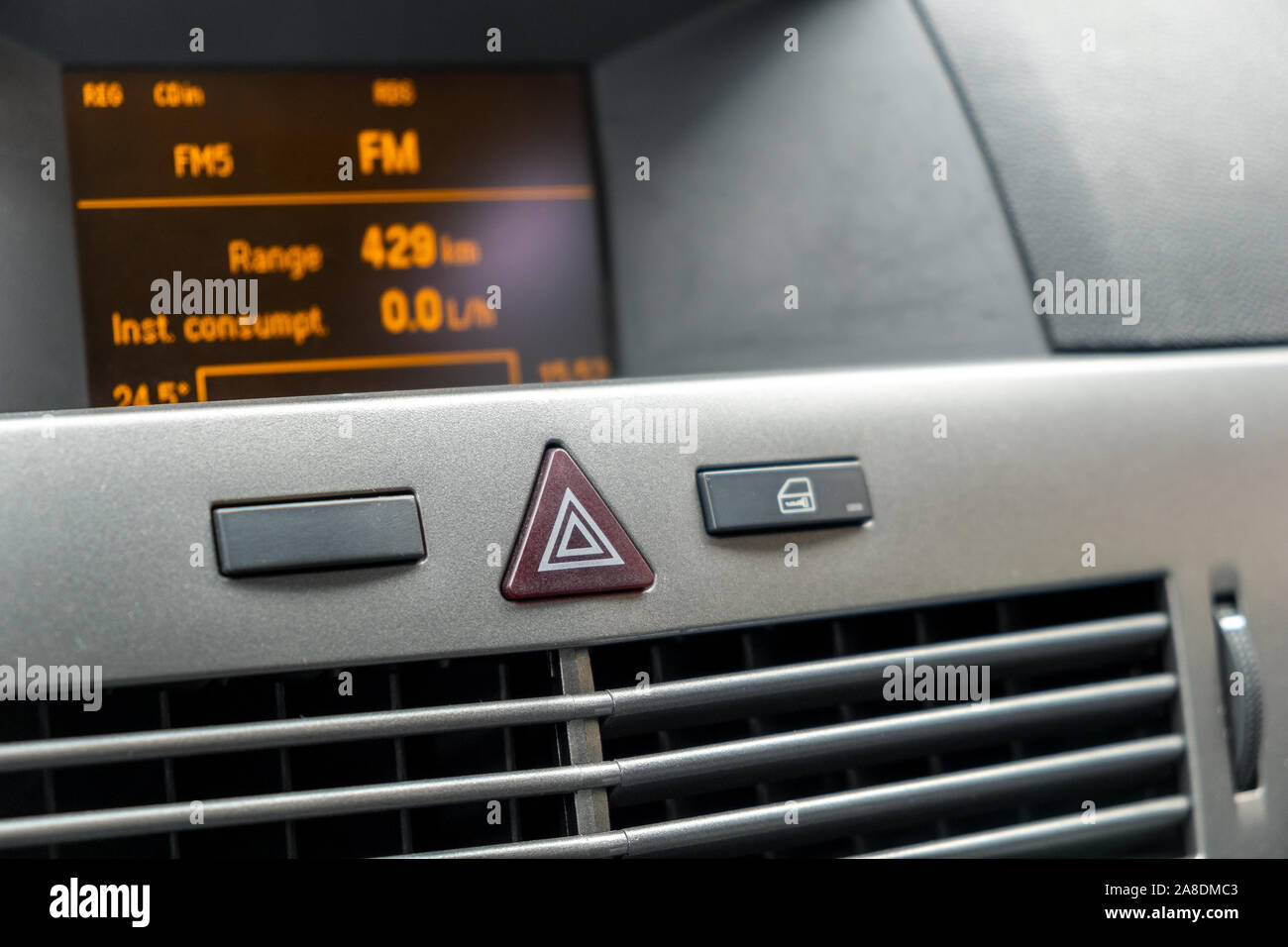 Red triangle emergency button in a car interior Stock Photo - Alamy