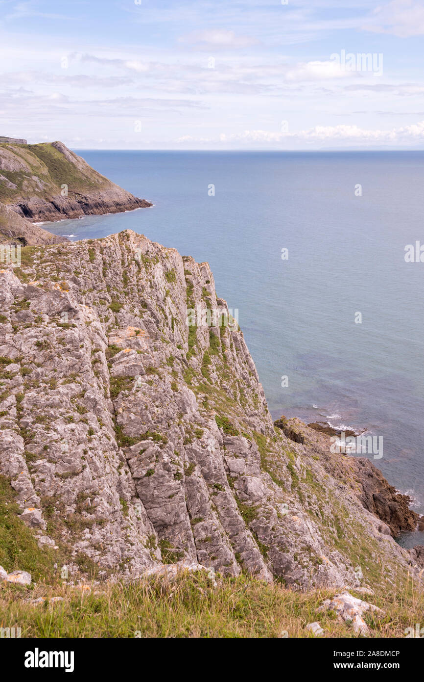 Rocky cliffs line the dramatic coast of Wales on the Gower Peninsula ...