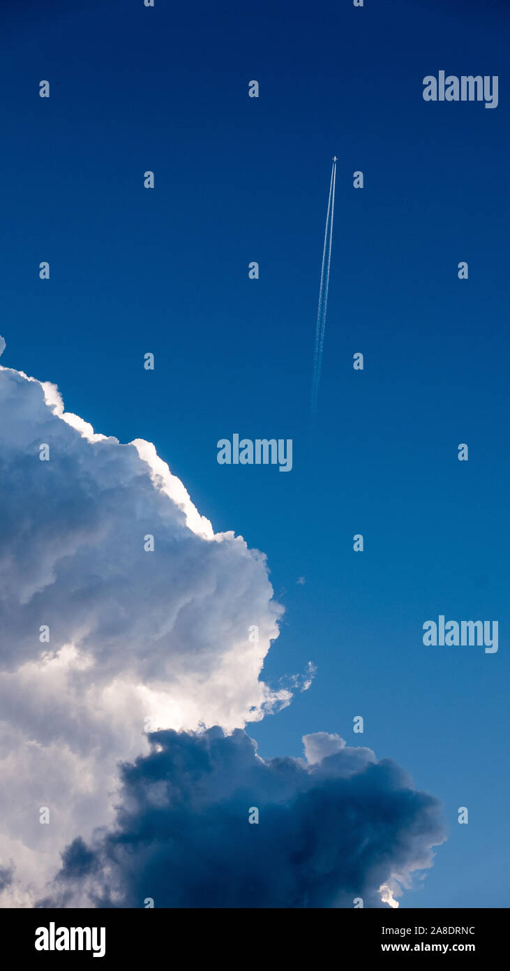 Jet with Contrail emerges from Thunderhead Stock Photo - Alamy