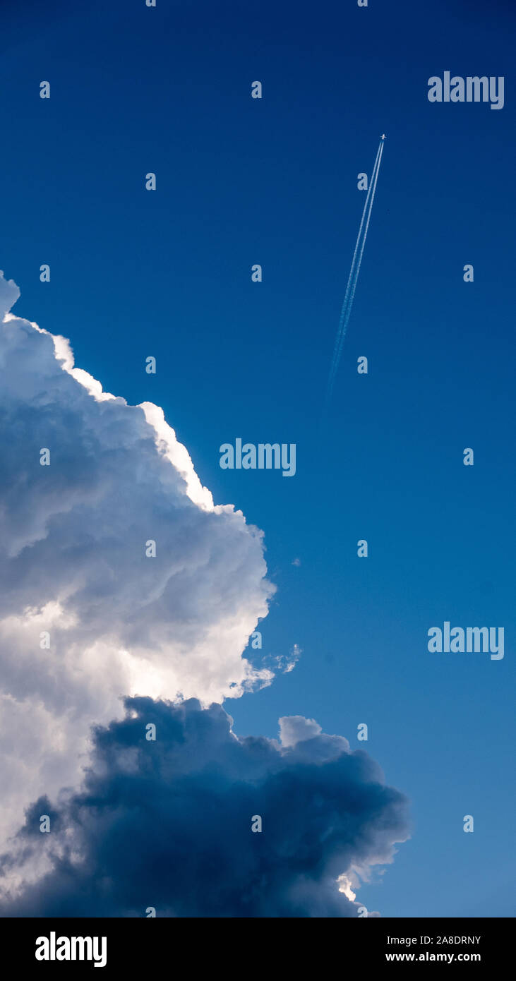 Jet with Contrail emerges from Thunderhead Stock Photo - Alamy