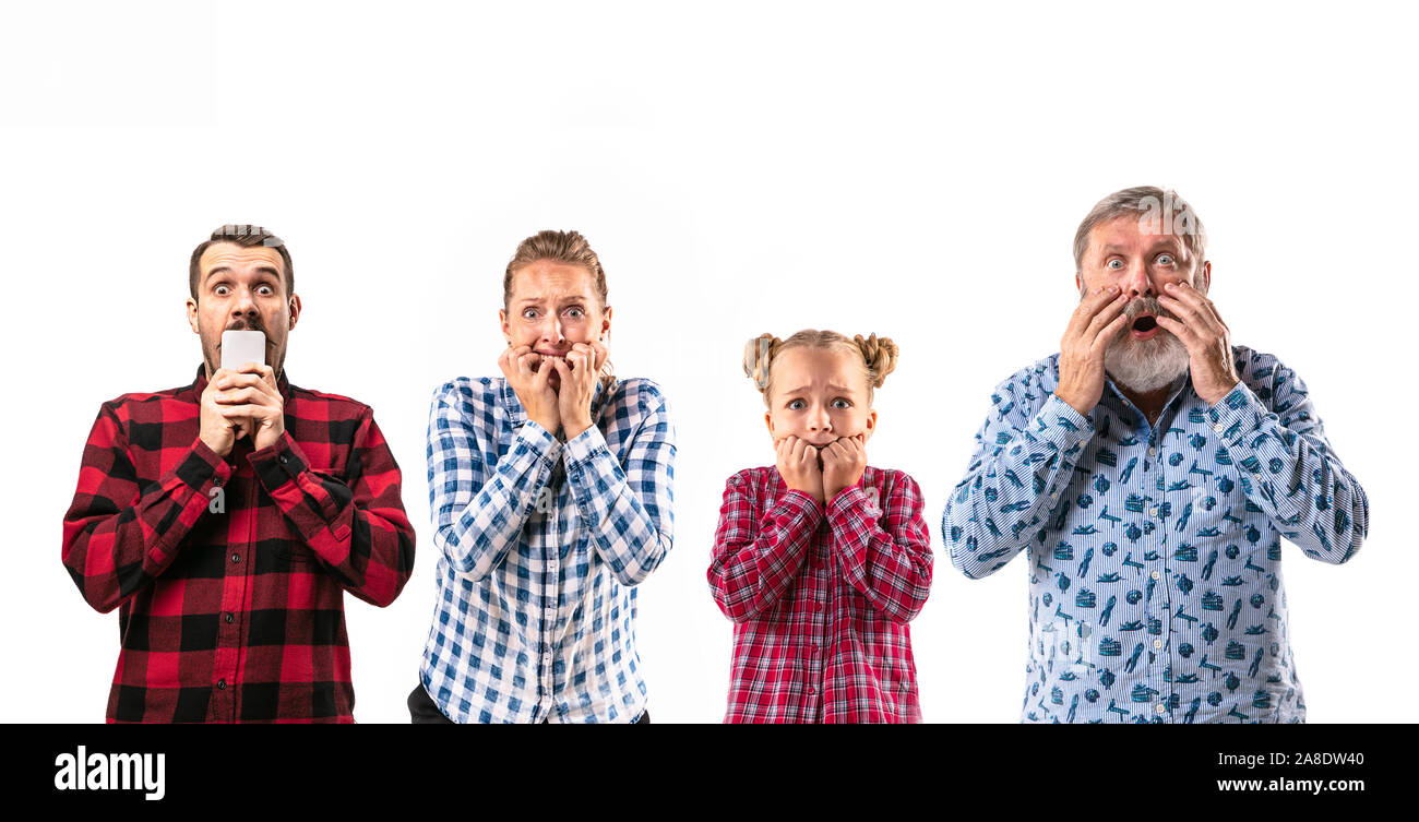 Family members looks scared and shocked on white studio background ...