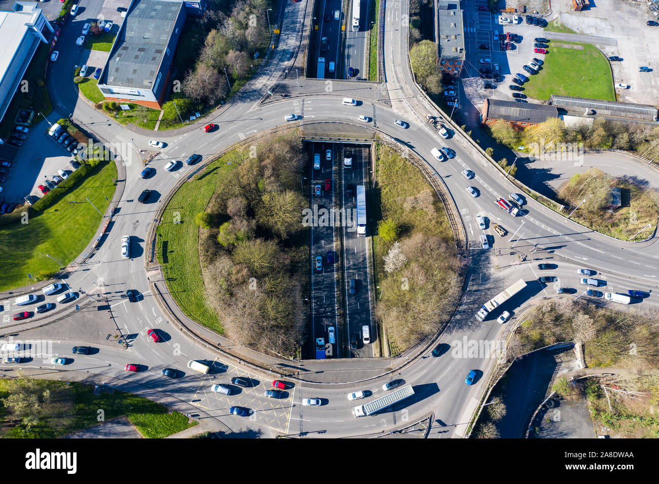 Overhead, aerial views of a roundabout at rush hour, busy with traffic ...