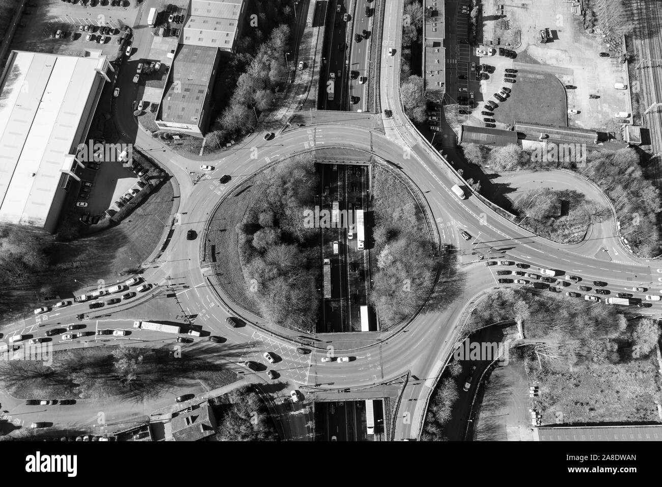 Overhead, aerial views of a roundabout at rush hour, busy with traffic ...