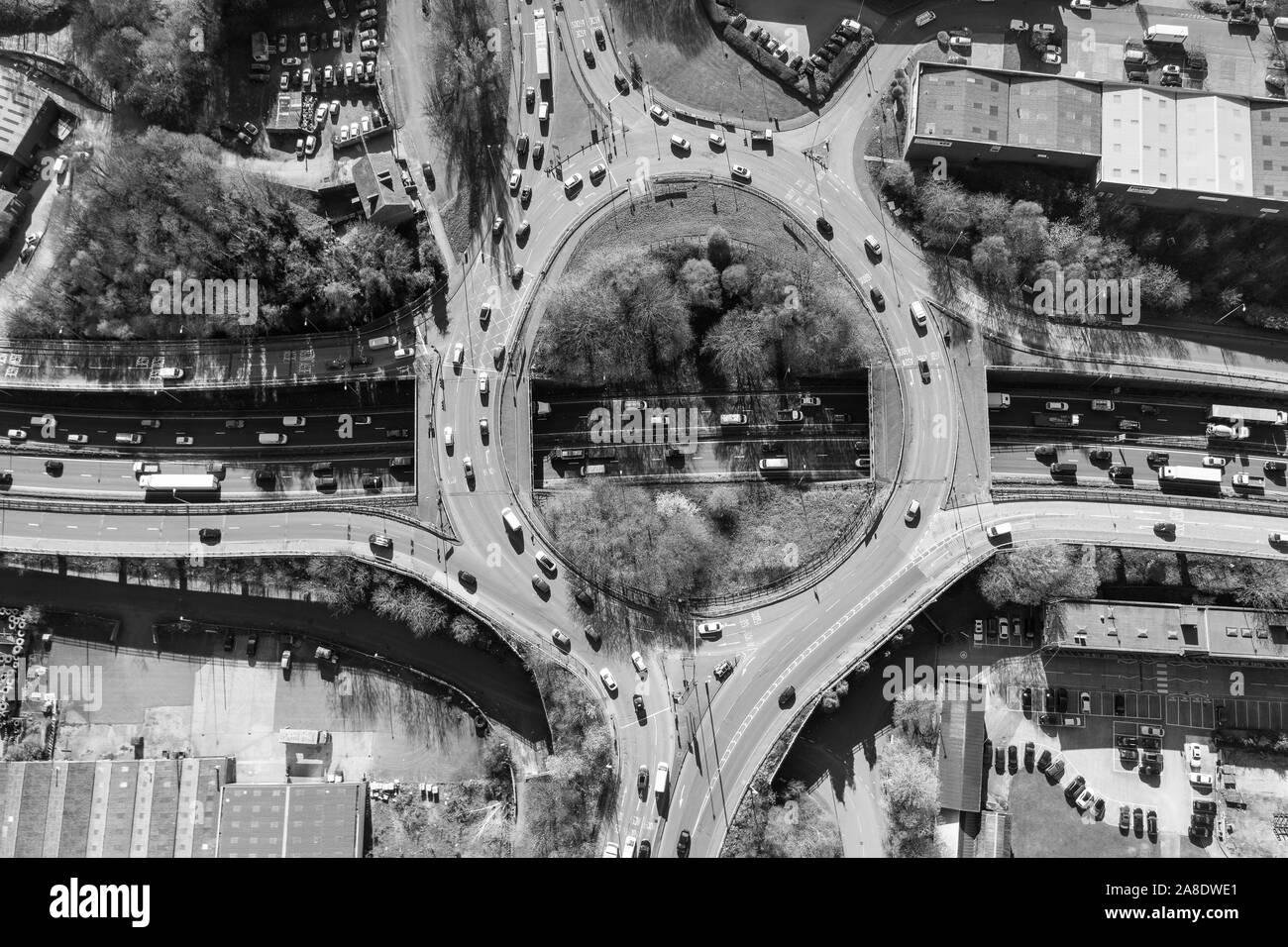Overhead, aerial views of a roundabout at rush hour, busy with traffic ...