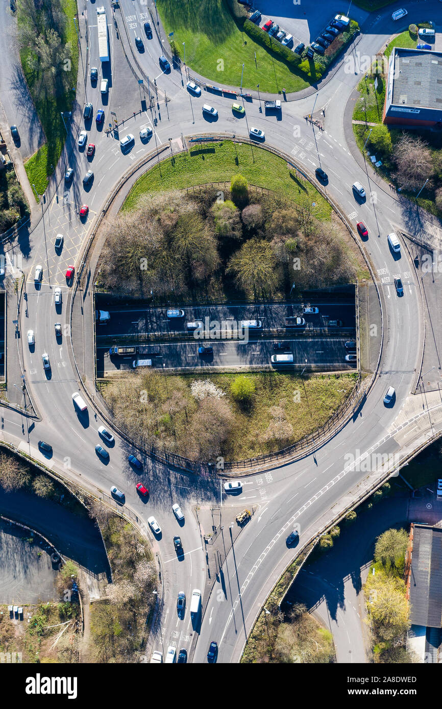 Overhead, aerial views of a roundabout at rush hour, busy with traffic ...