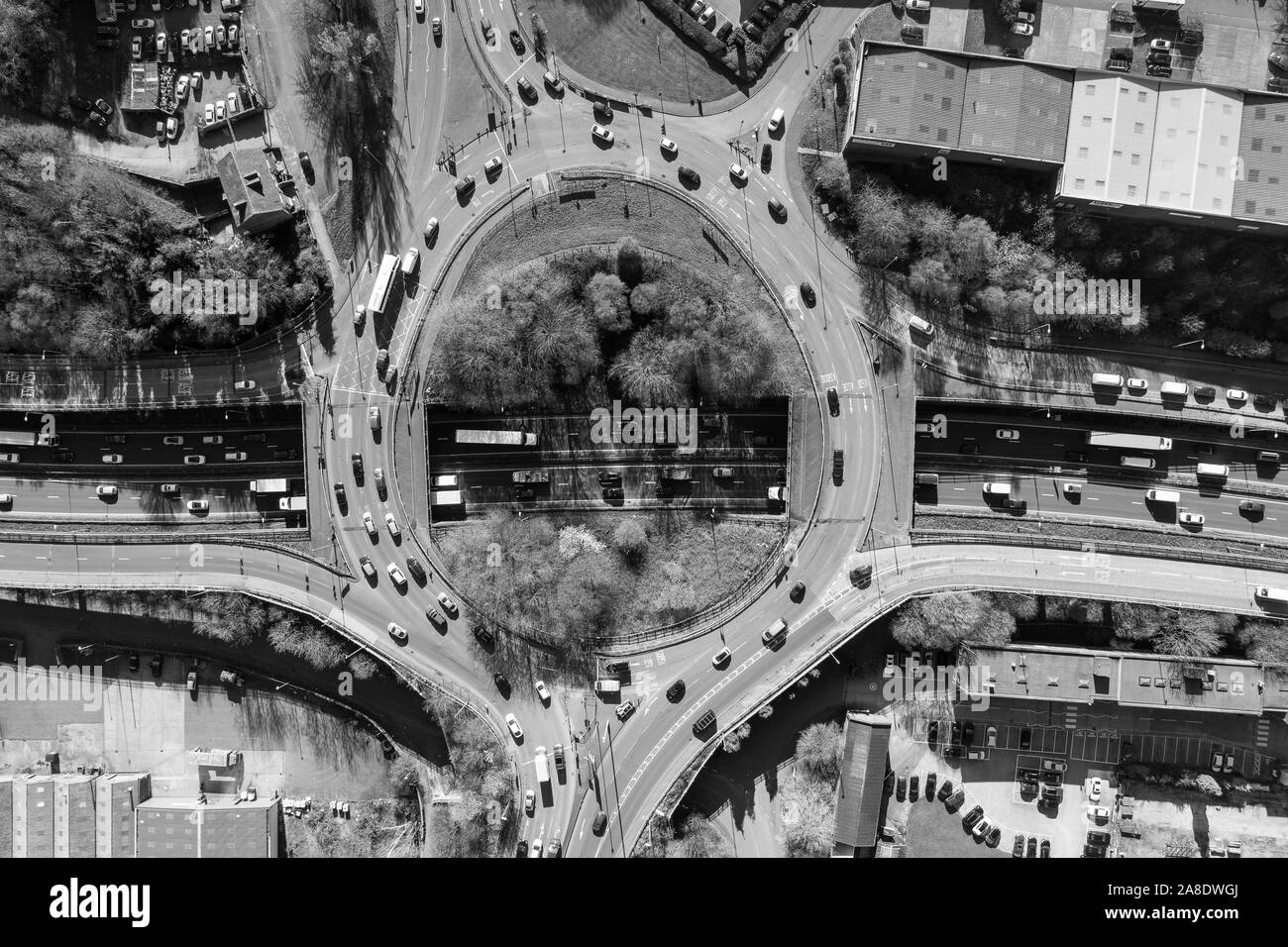 Traffic on roundabout road junction Black and White Stock Photos ...
