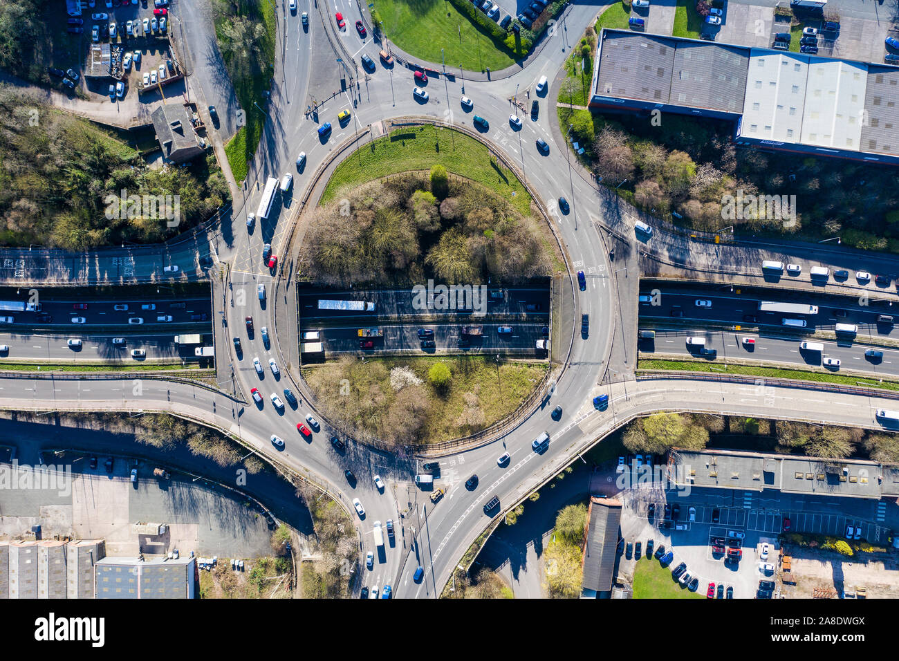 Overhead, aerial views of a roundabout at rush hour, busy with traffic ...