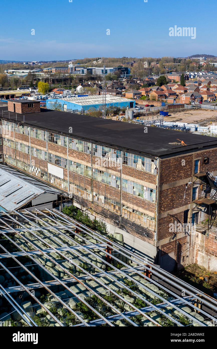 Aerial, overhead views of an abandoned factory, left to decline in the ...