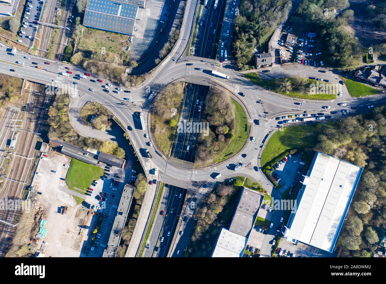 Overhead, aerial views of a roundabout at rush hour, busy with traffic ...