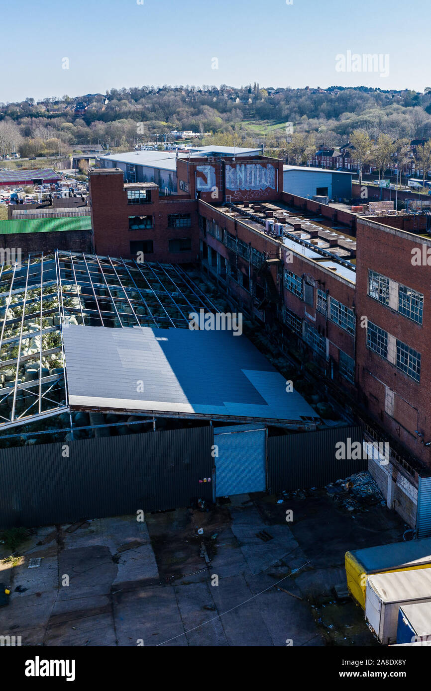 Aerial, overhead views of an abandoned factory, left to decline in the ...