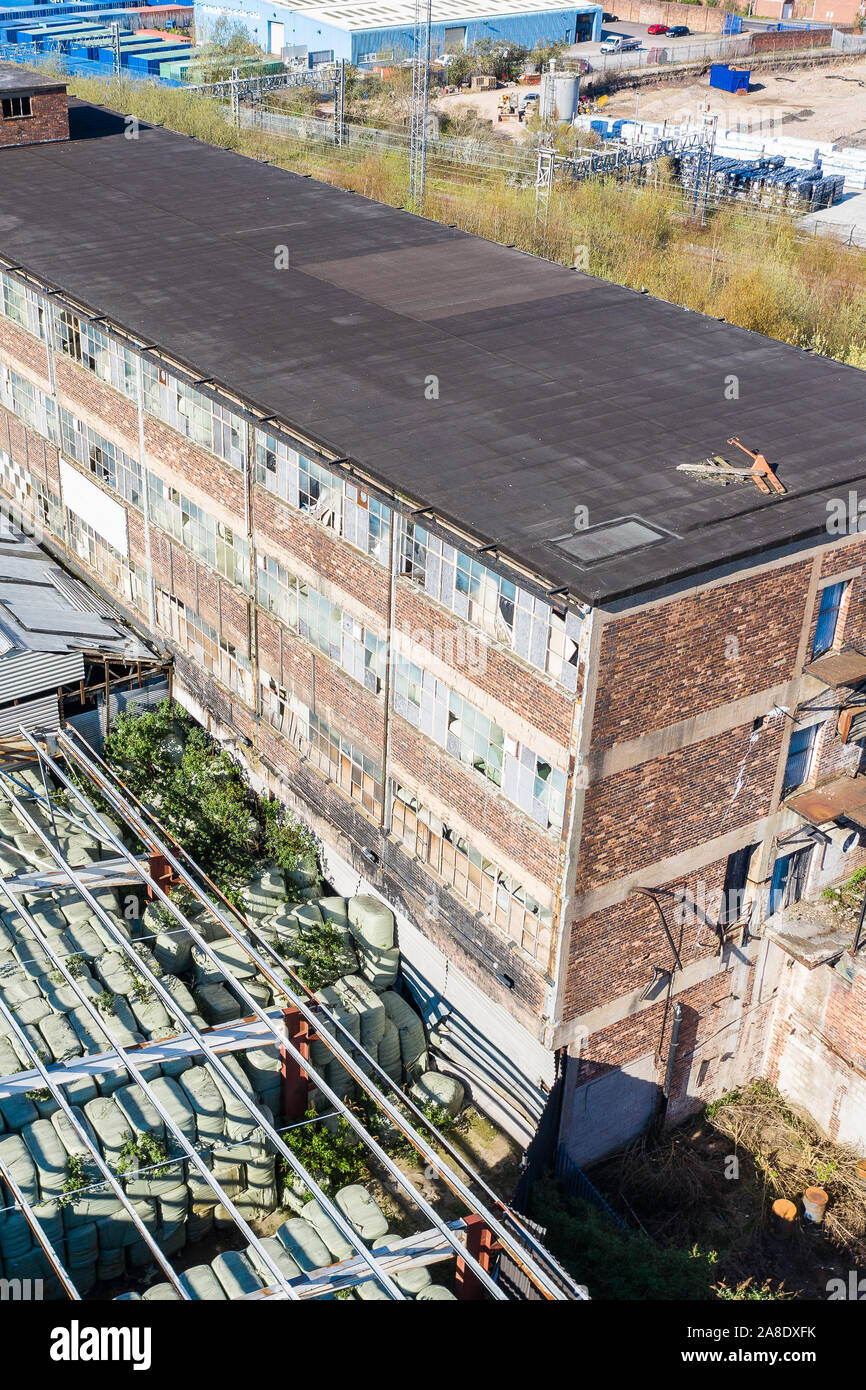 Aerial, overhead views of an abandoned factory, left to decline in the ...
