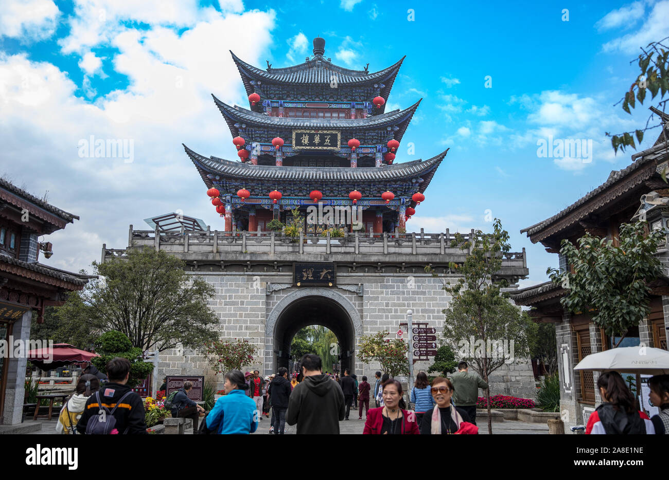 Tourists walk through Wuhua Tower in Dali Ancient Town in Dali City ...
