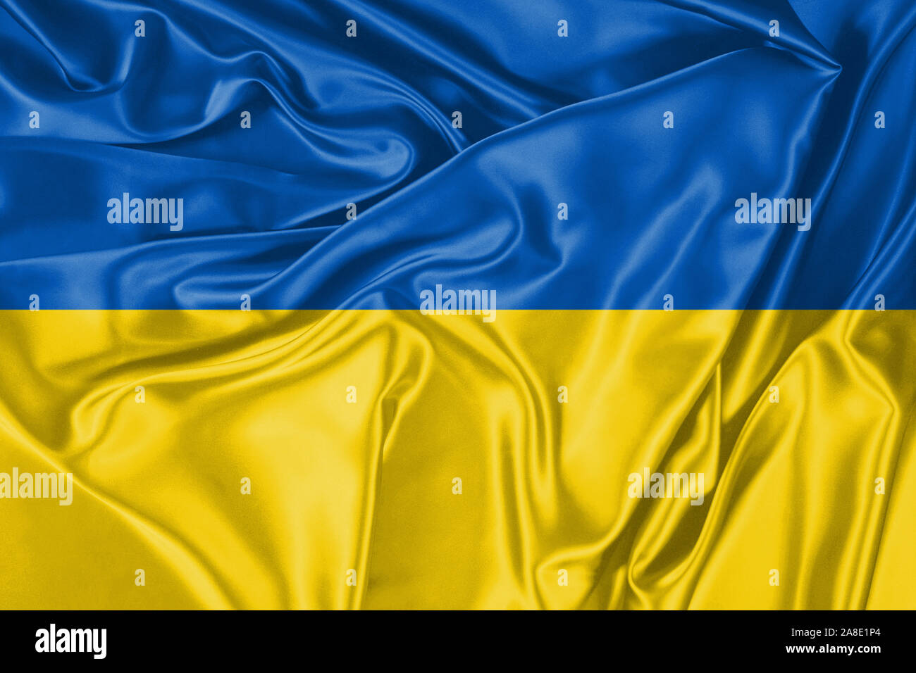 Shiny crippled Ukrainian flag is laying on a surface. Realistic ...