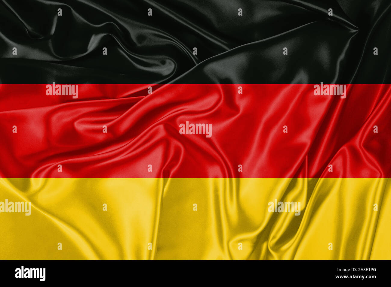 Shiny crippled German flag is laying on a surface. Realistic ...
