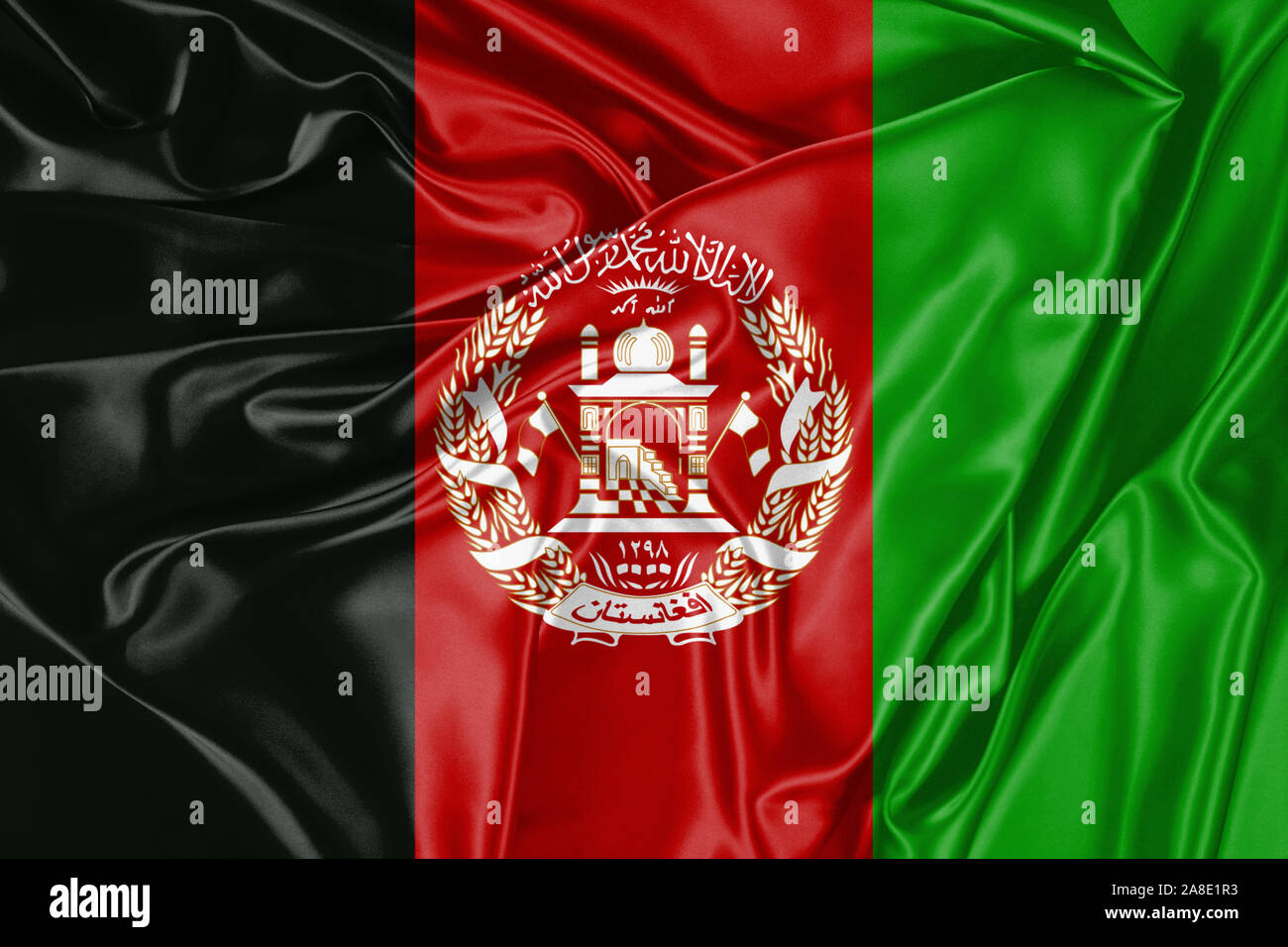 Shiny crippled Afghanistan flag is laying on a surface. Realistic ...