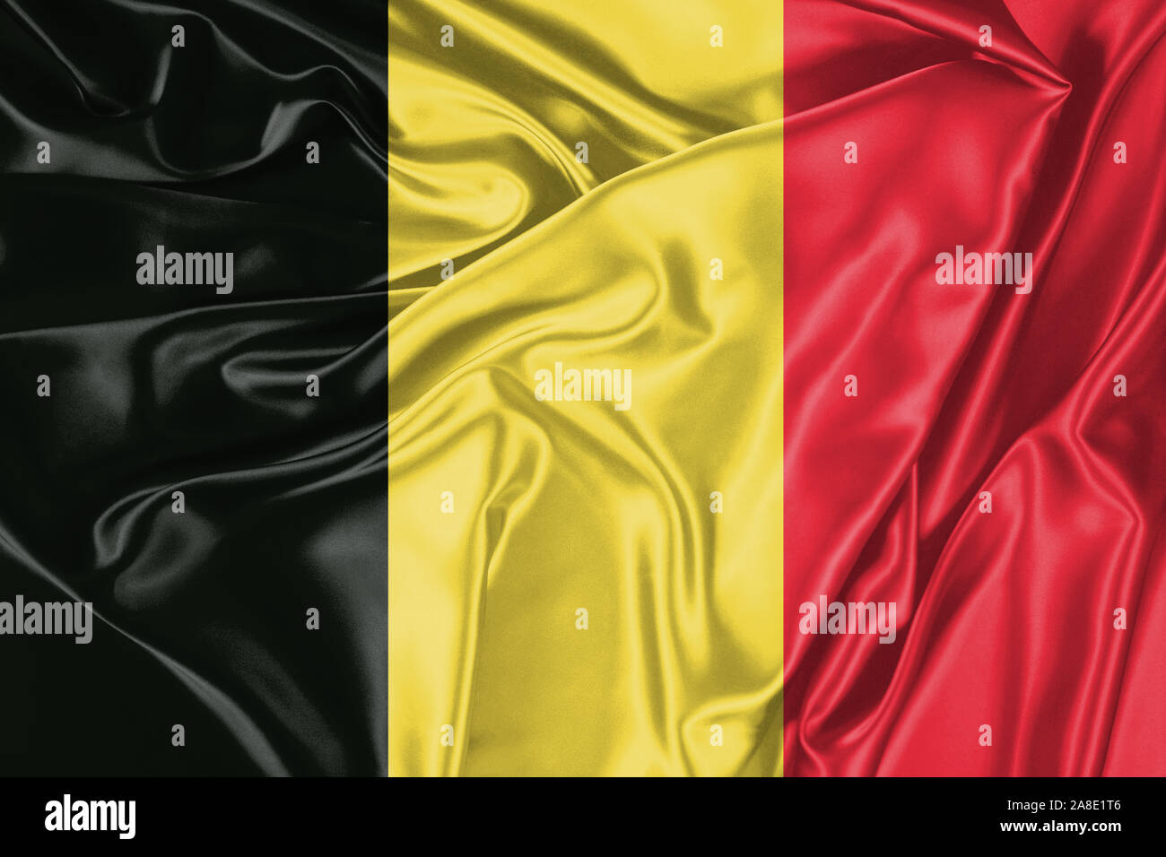 Shiny crippled Belgium flag is laying on a surface. Realistic ...
