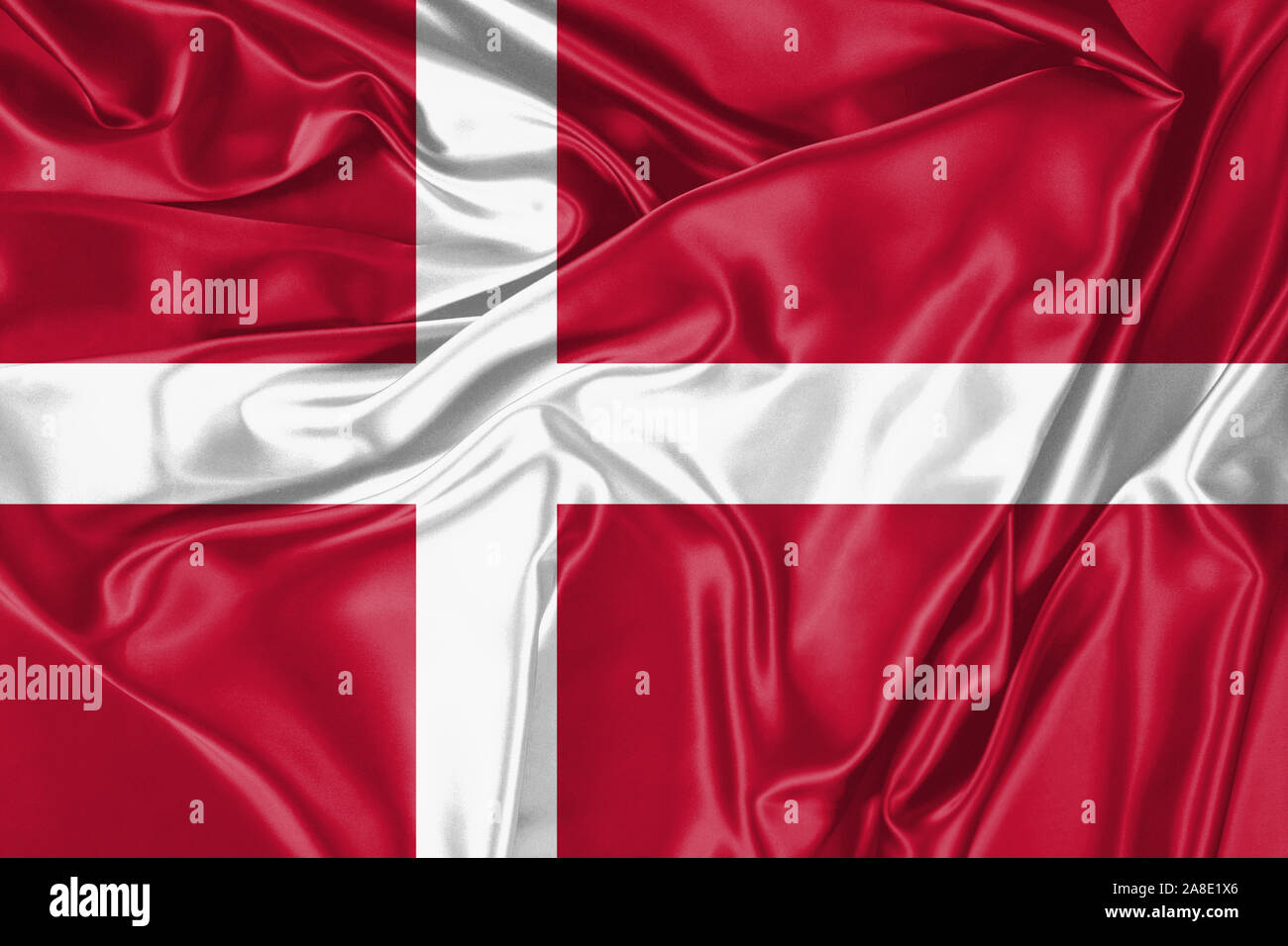 Shiny crippled Denmark flag is laying on a surface. Realistic ...