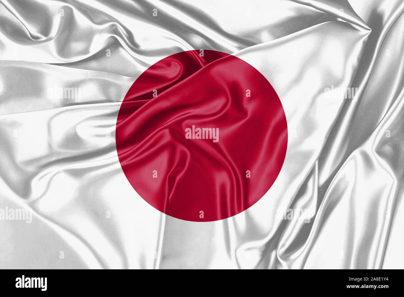 Shiny crippled Japanese flag is laying on a surface. Realistic ...