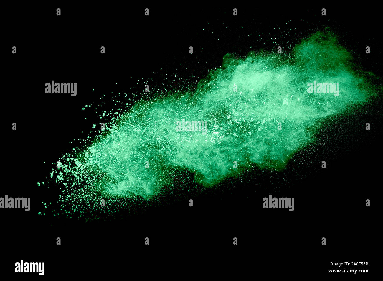 Green color powder explosion cloud on black background.Green dust ...