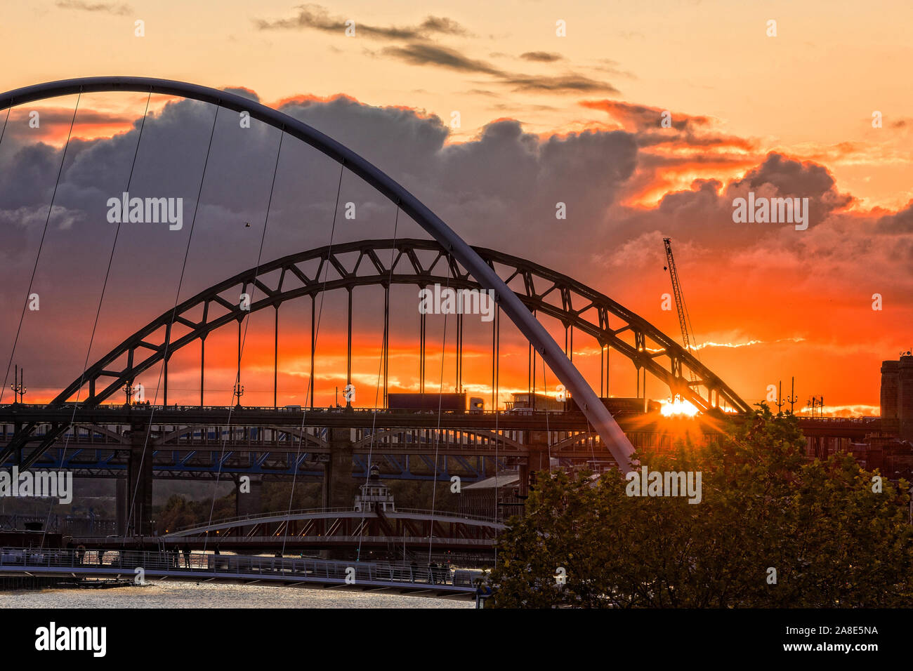 Tyne and millennium bridges at sunset hi-res stock photography and ...