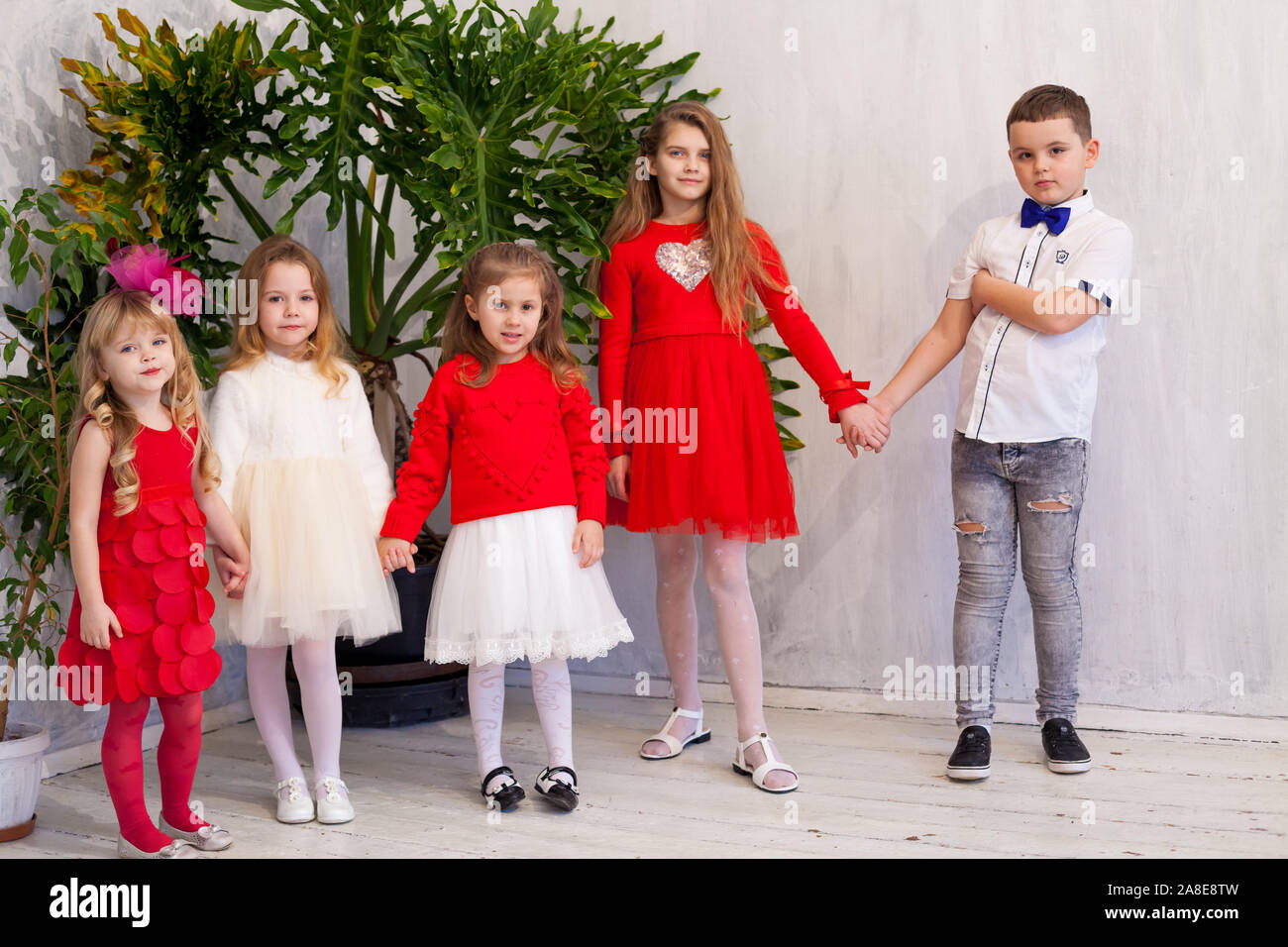 kids are friends of different ages together in a white room Stock Photo ...