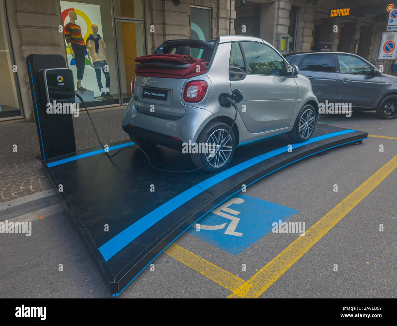 Smart, electric car being charged exhibited in the Conegliano Auto Expo ...