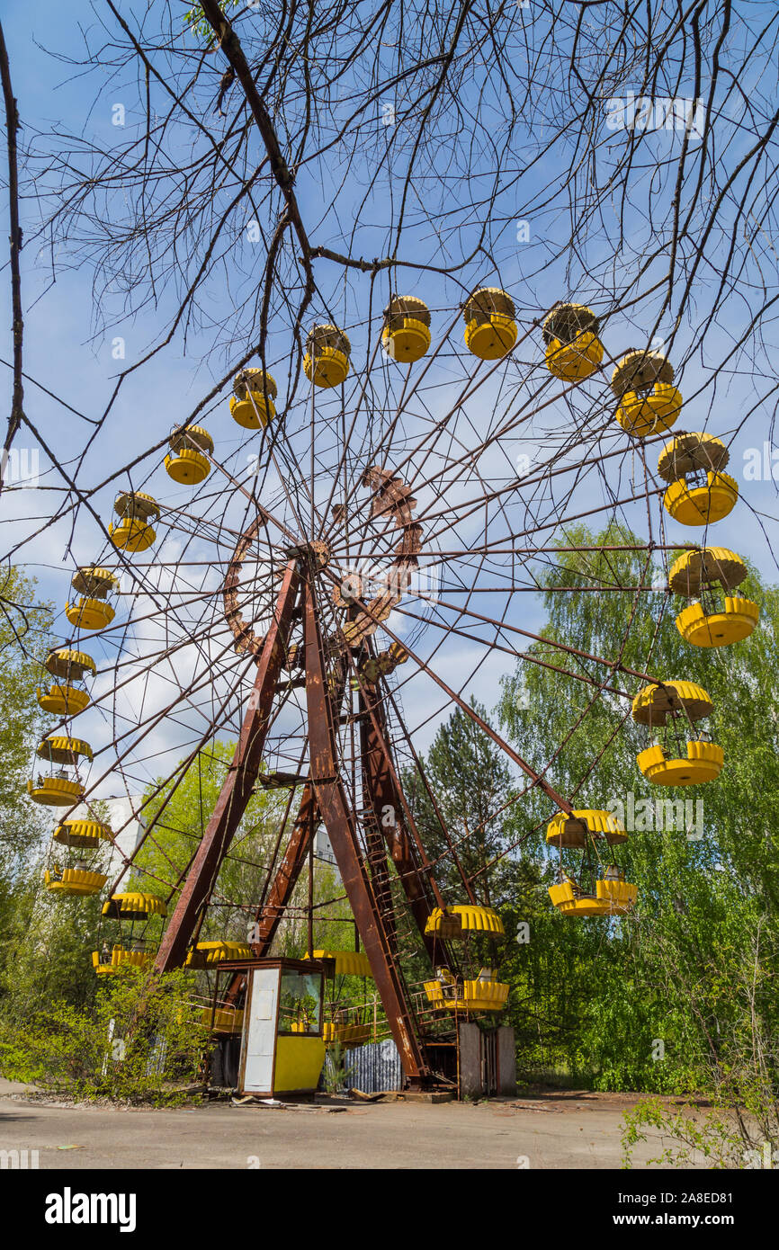 Old broken rusty metal radioactive electric wheel abandoned, the park ...