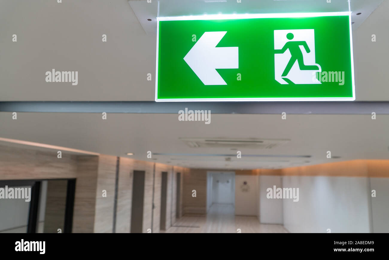 Green fire escape sign hang on the ceiling in the office Stock Photo ...