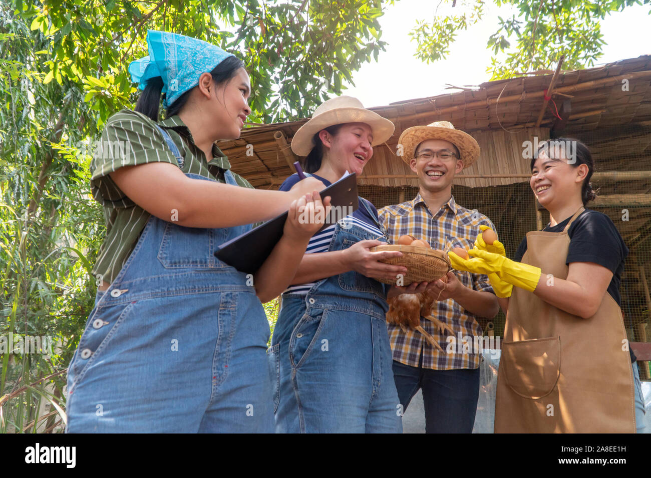 Group of farmers smiling and standing beside chicken farm. All Smiling ...