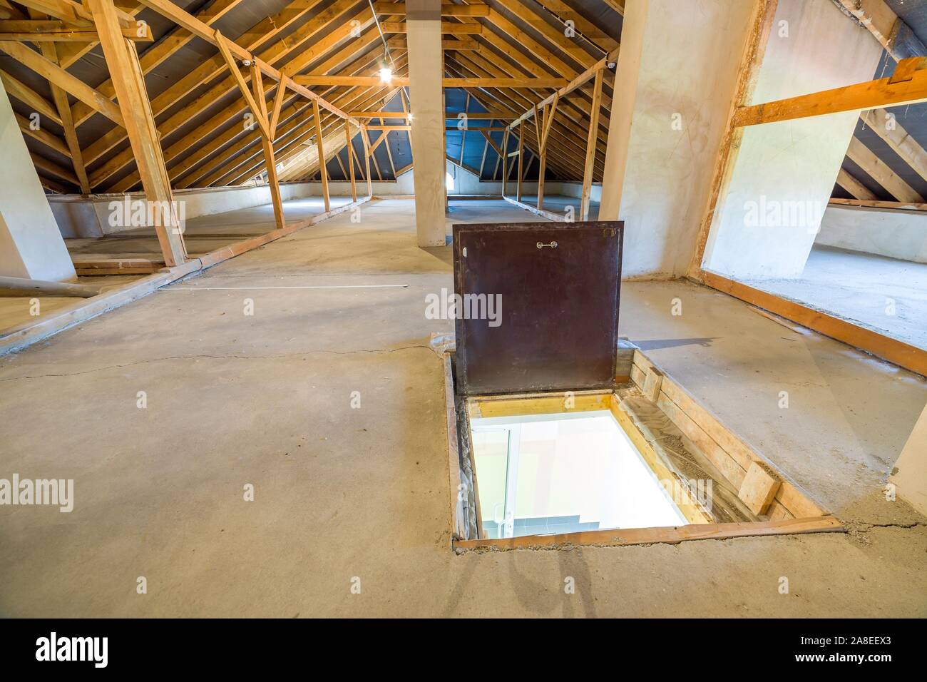 Attic of a building with wooden beams of a roof structure and a fire ...