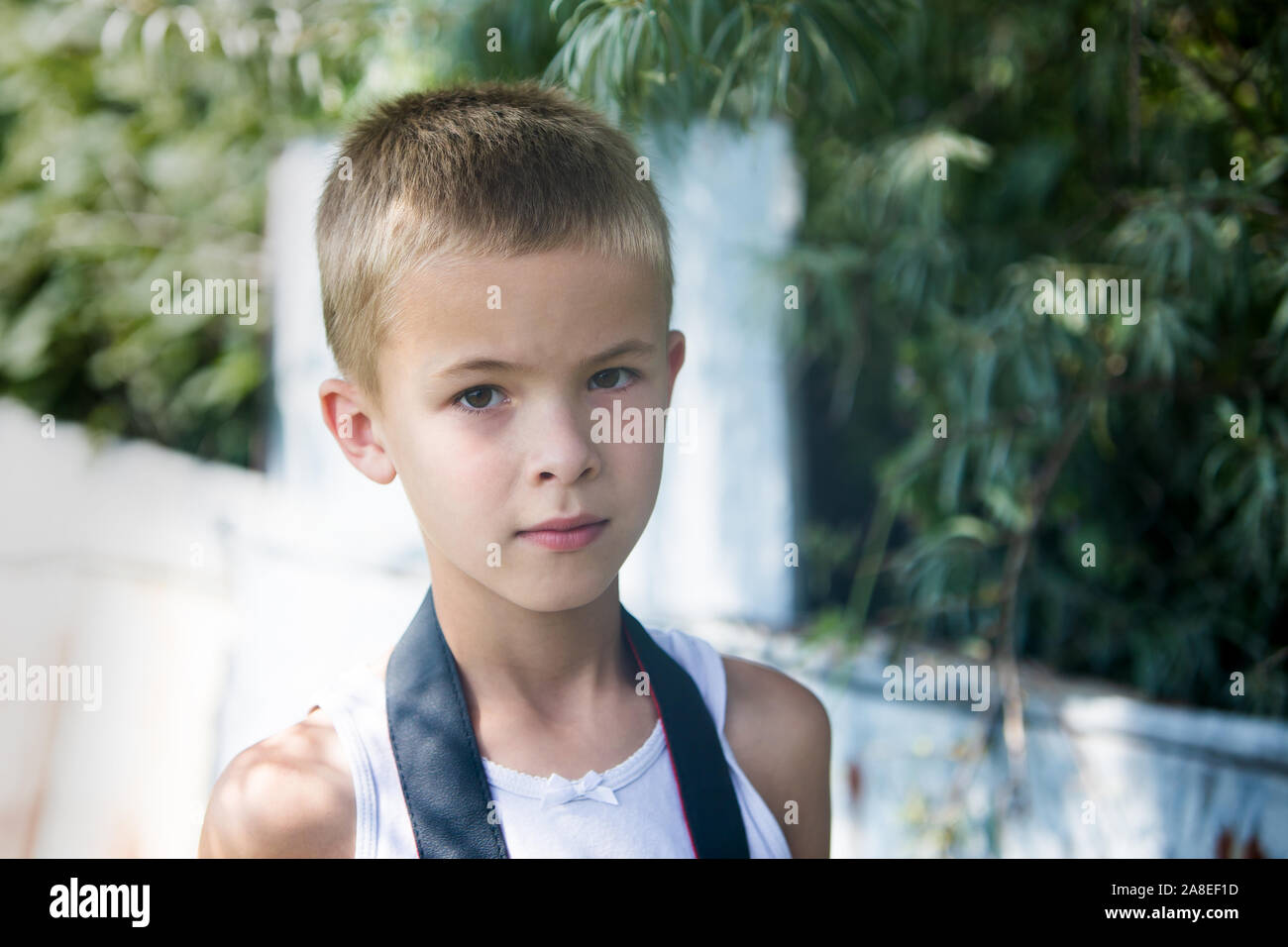 Portrait of a serious child boy outdoors Stock Photo - Alamy