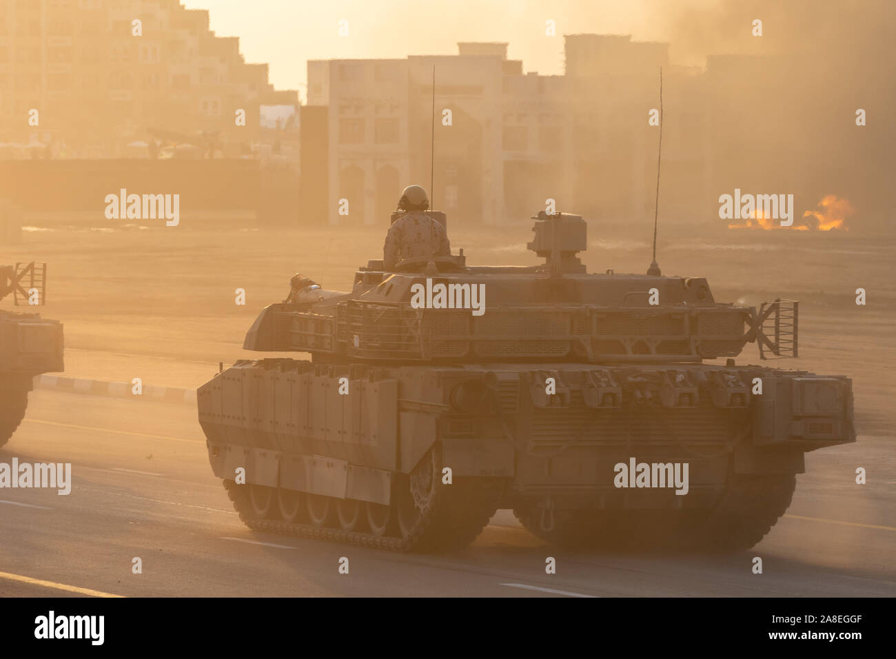 Military army tank vehicles driving down the road with guns and ...