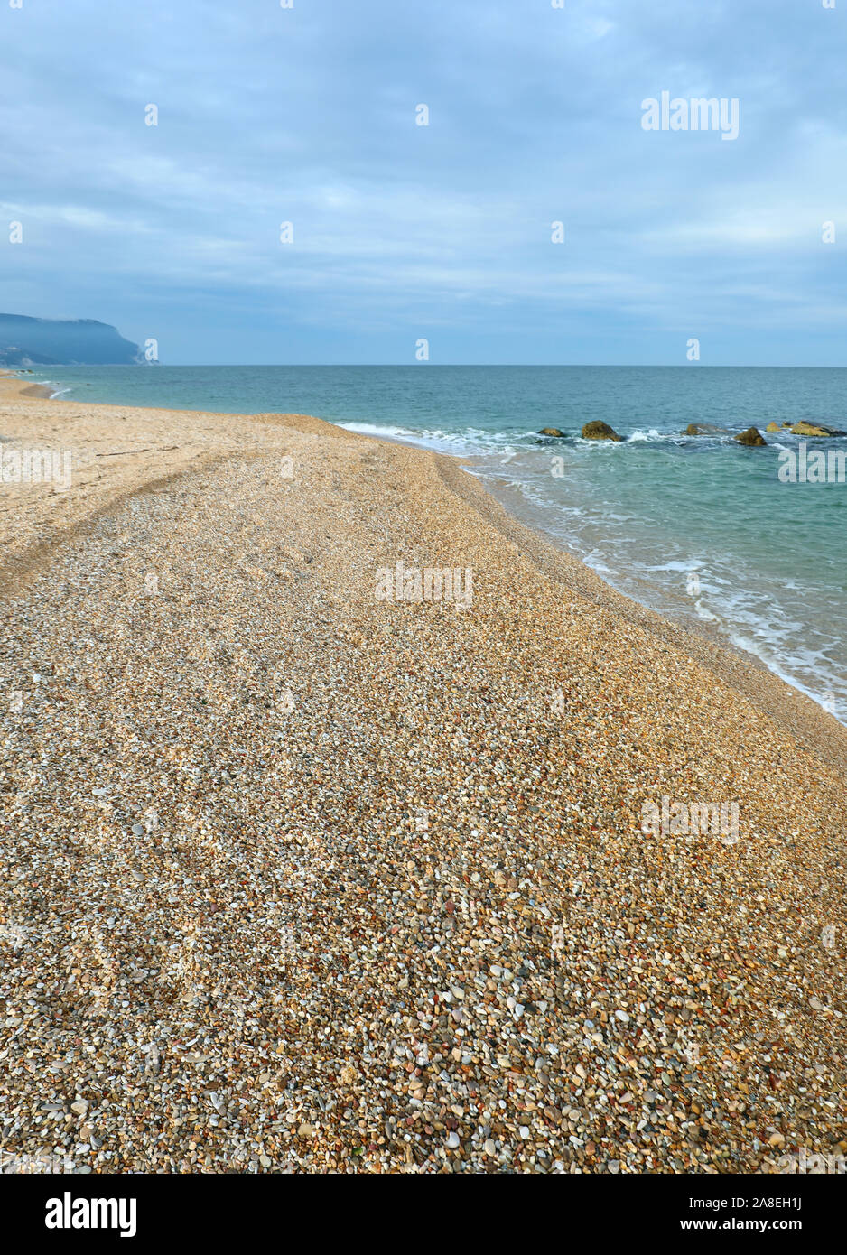 long beach with many small pebbles without sand Stock Photo - Alamy
