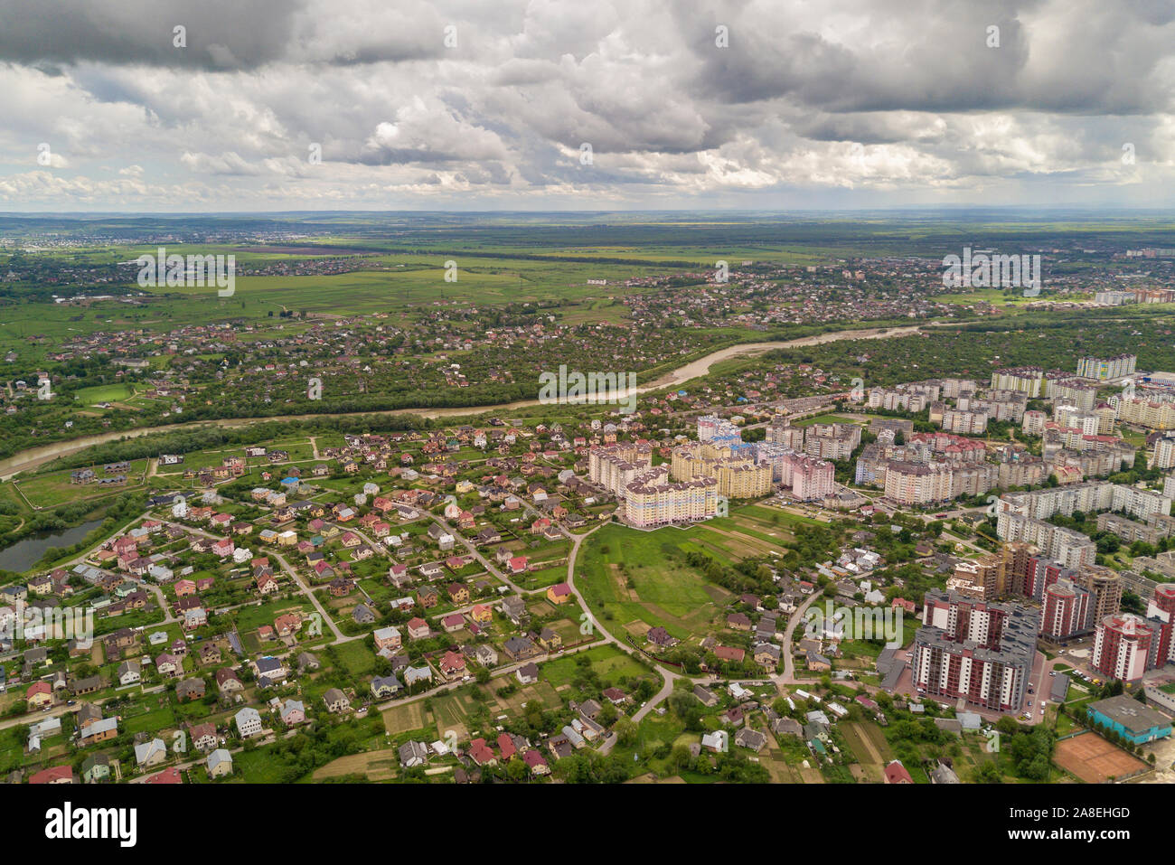 Aerial view of town or city with rows of buildings and curvy streets in ...