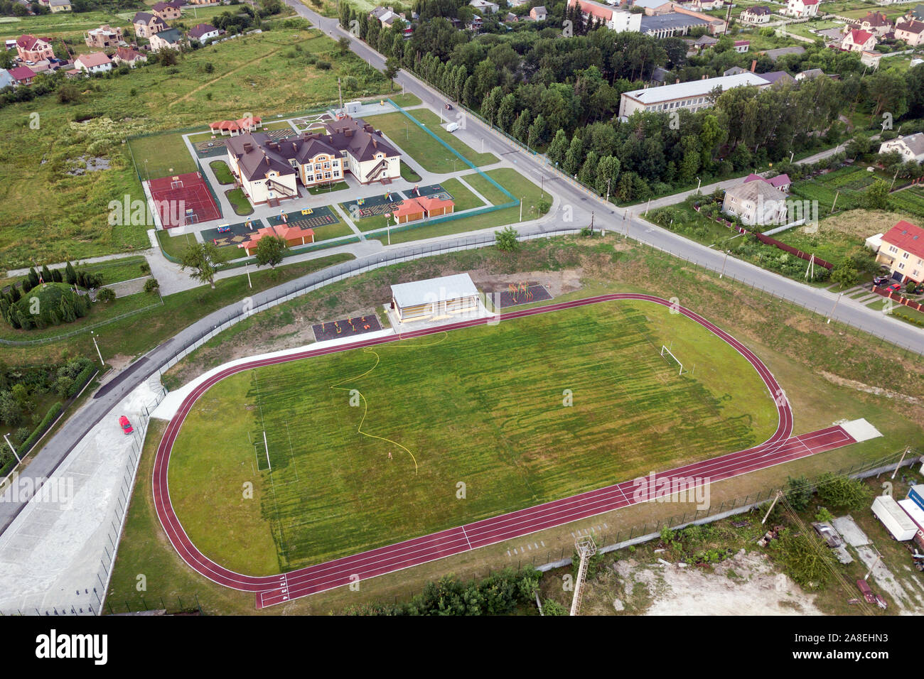 Aerial view of a football field on a stadium covered with green grass ...