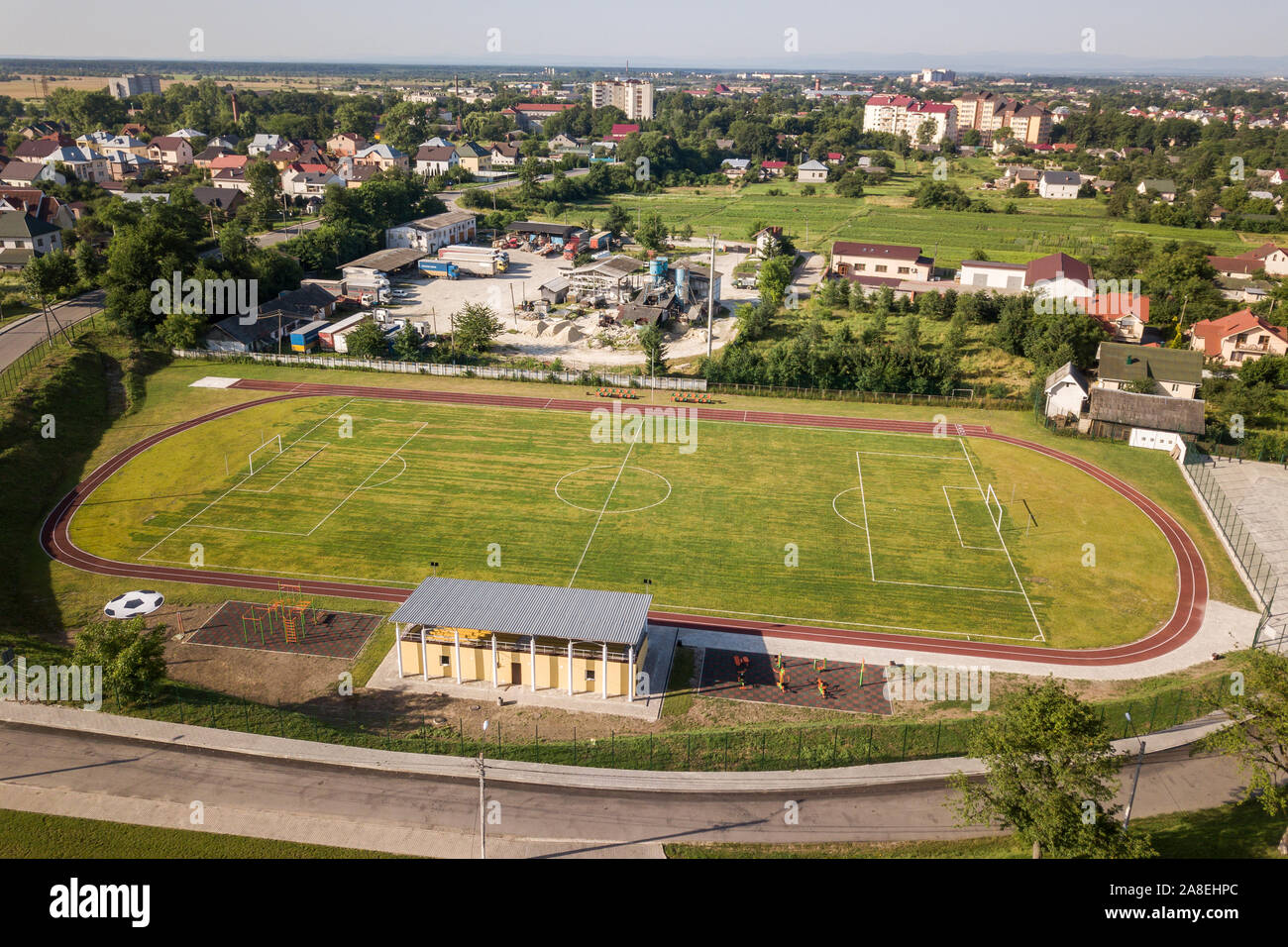 Aerial view of a football field on a stadium covered with green grass ...