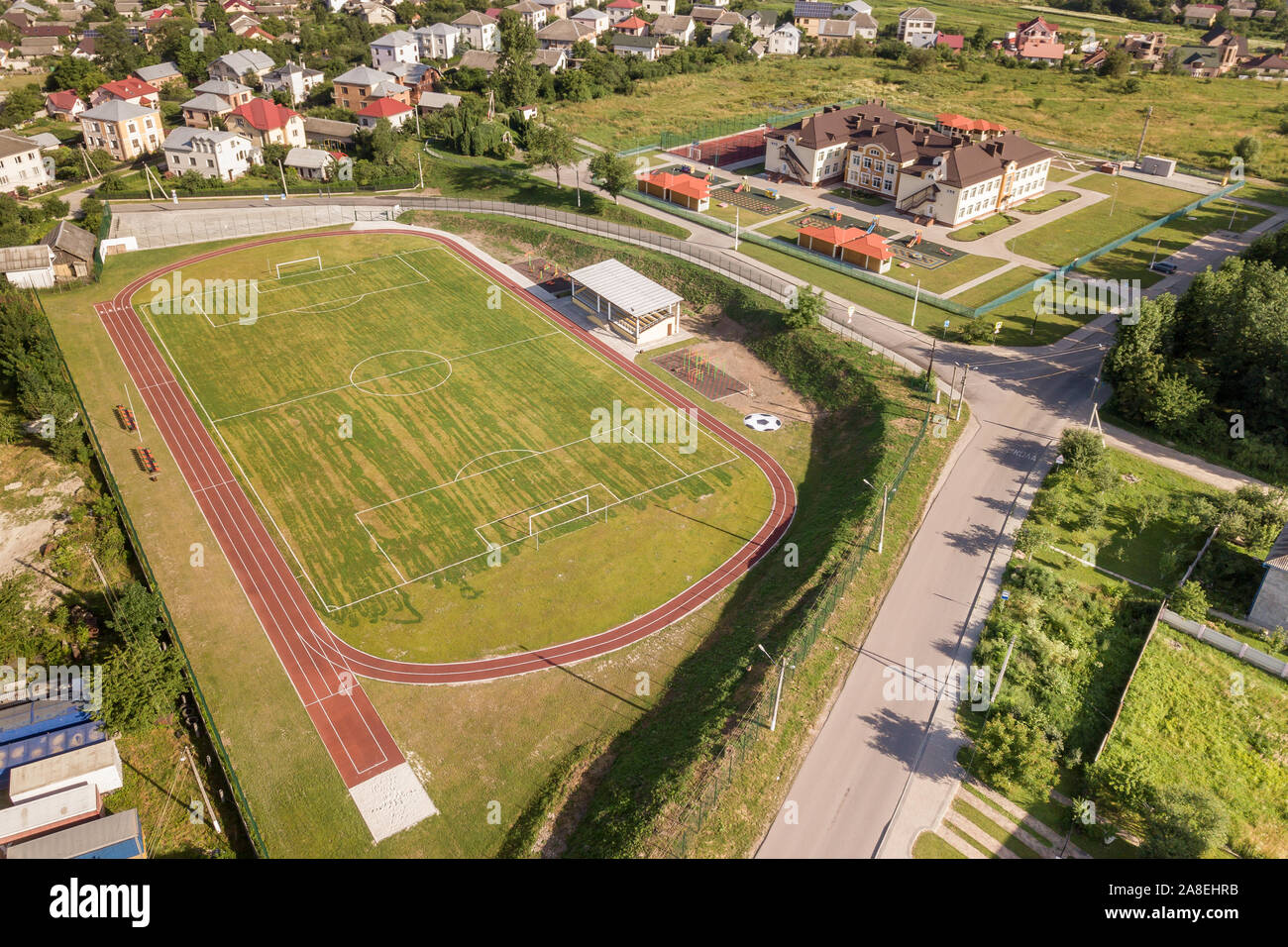 Aerial view of a football field on a stadium covered with green grass ...