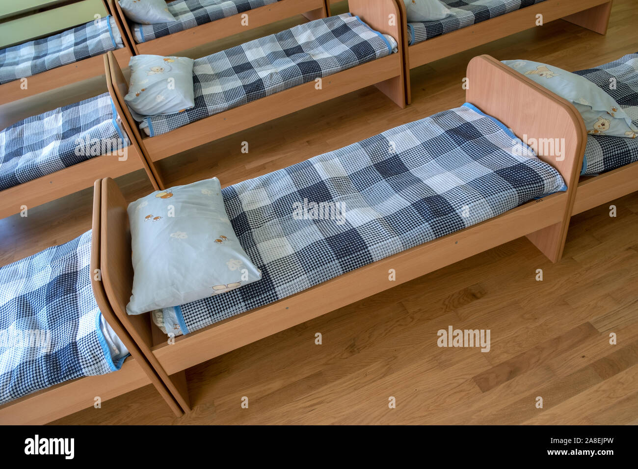 Many small beds in daycare preeschool empty bedroom Stock Photo - Alamy