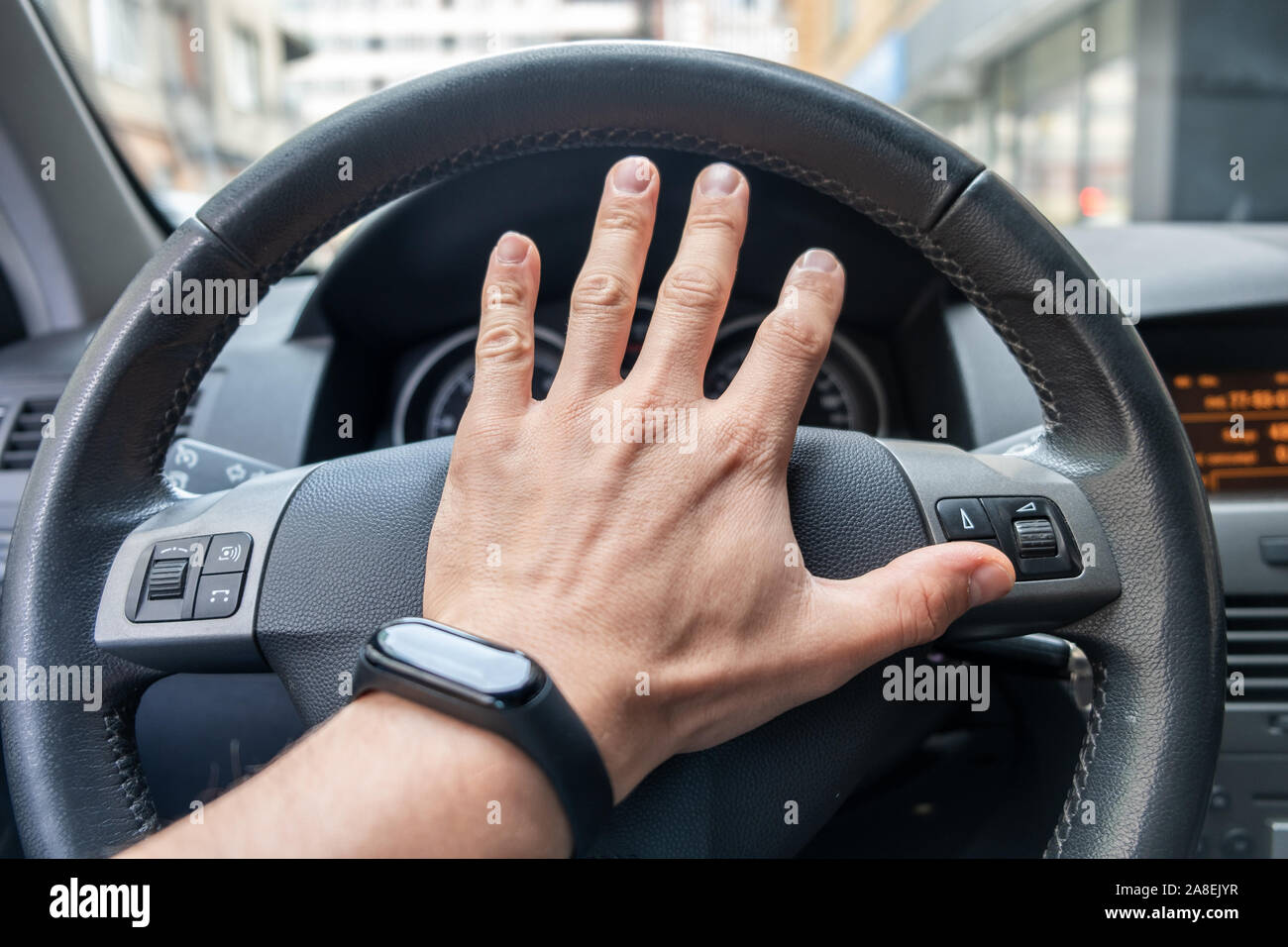 Drivers hand on a steering wheel of a car Stock Photo - Alamy