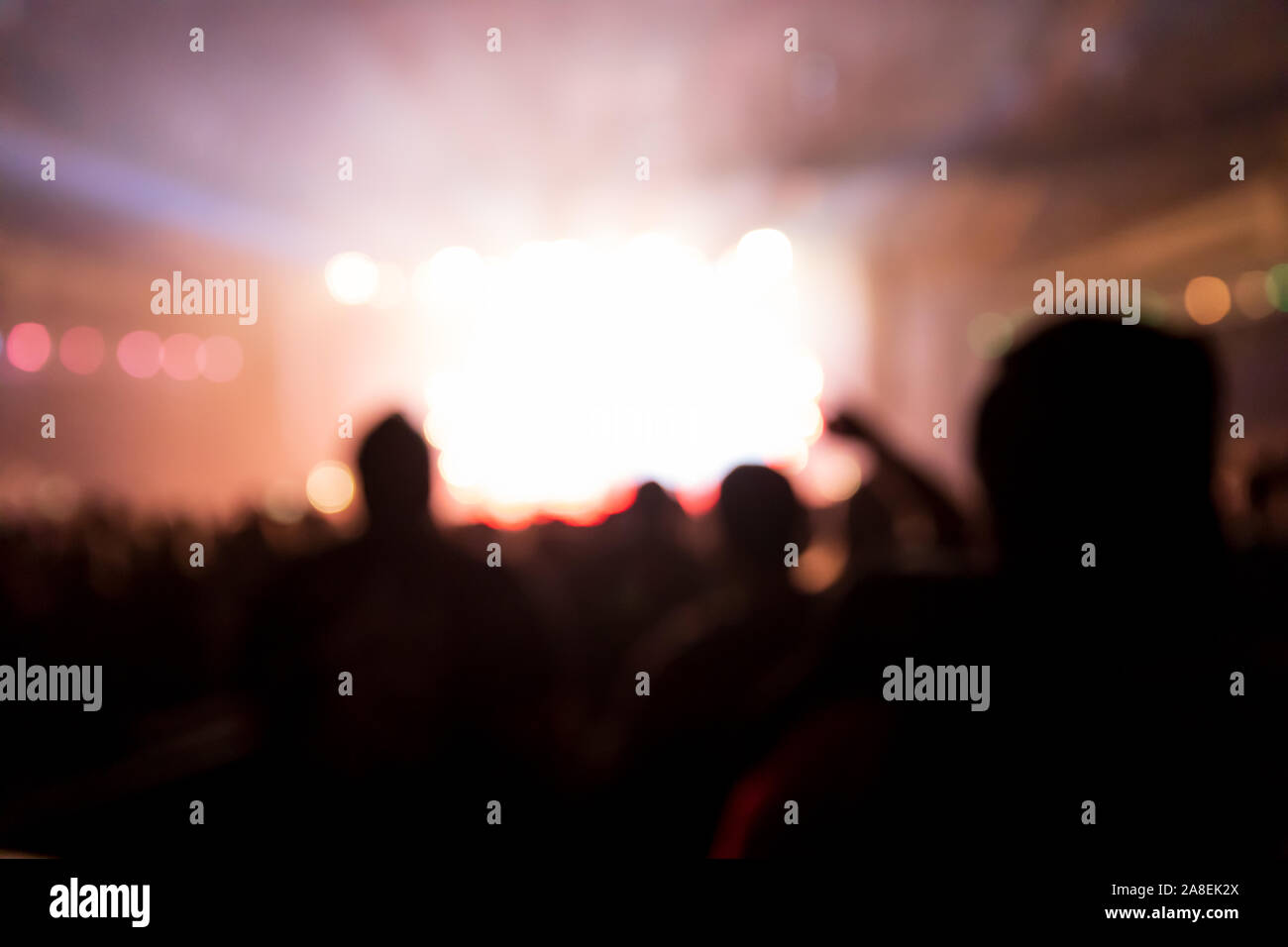 Out of focus crowd at a concert with a bright stage Stock Photo - Alamy
