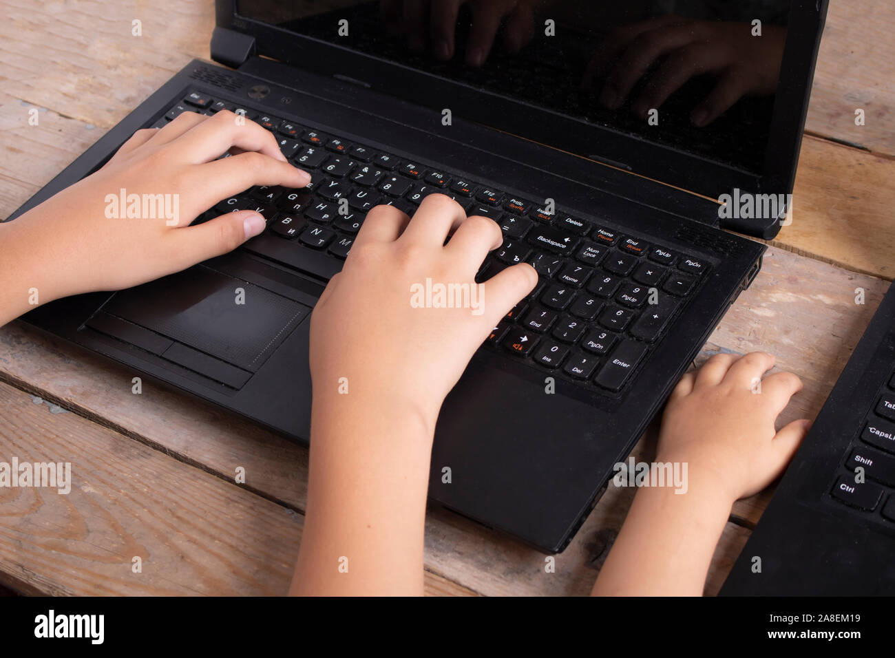 kids hands lying on a laptop, sitting at computer Stock Photo - Alamy