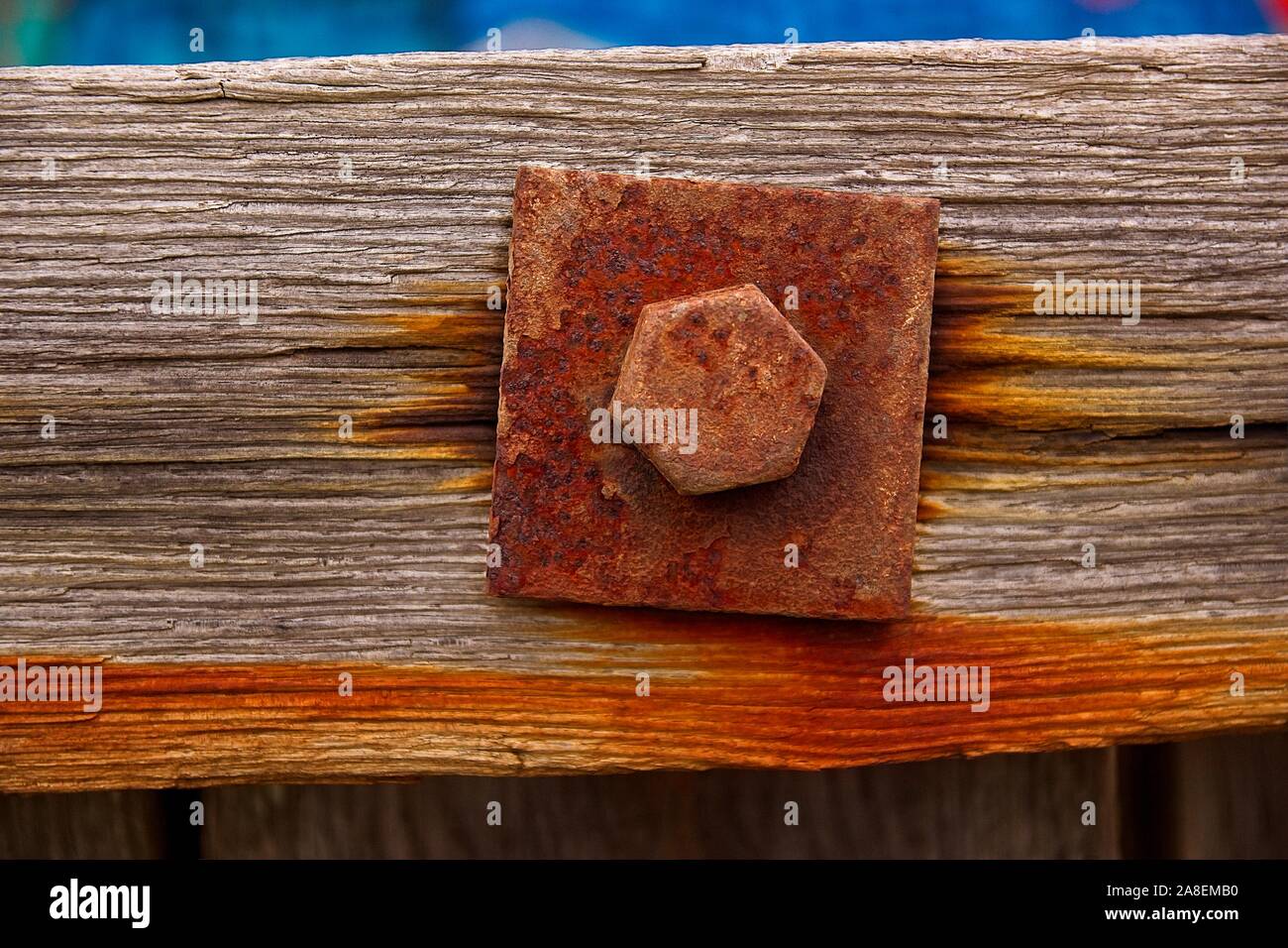 Weathered wooden construction open to sea air Close up of rusting bolt ...