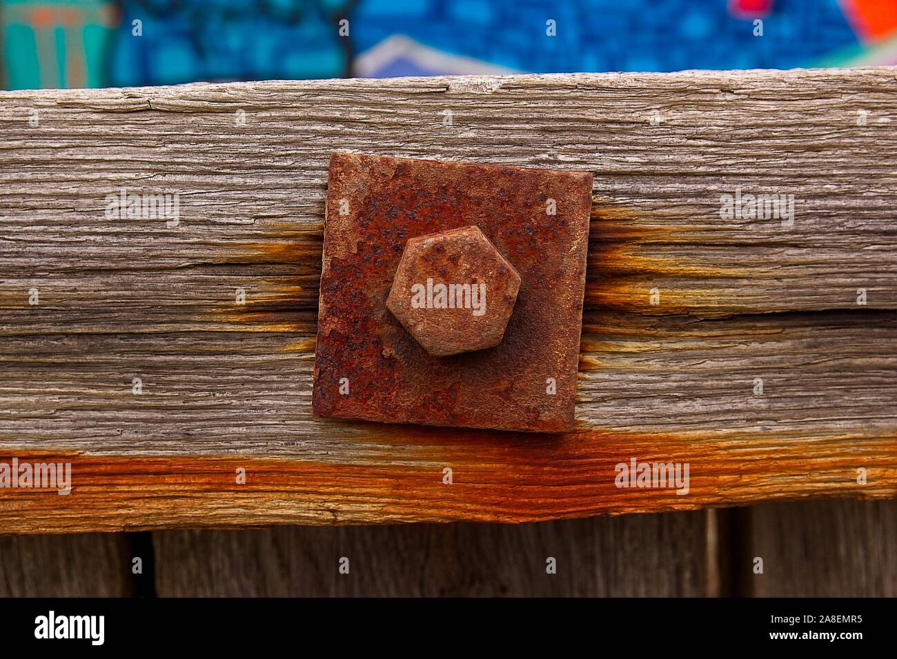 Weathered wooden construction open to sea air Close up of rusting bolt ...