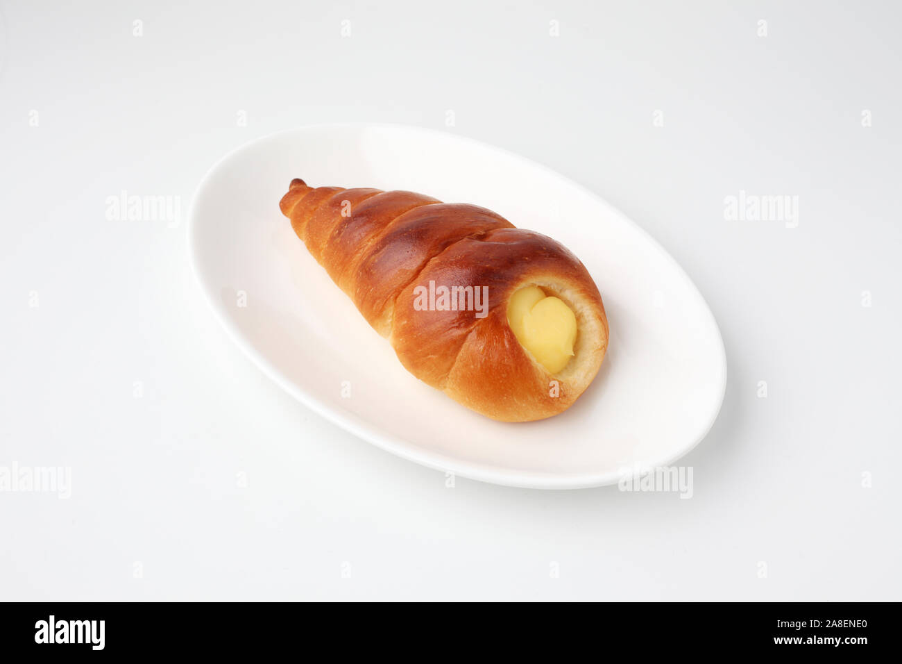 cream cornet roll bread on plate isolated on white background Stock ...