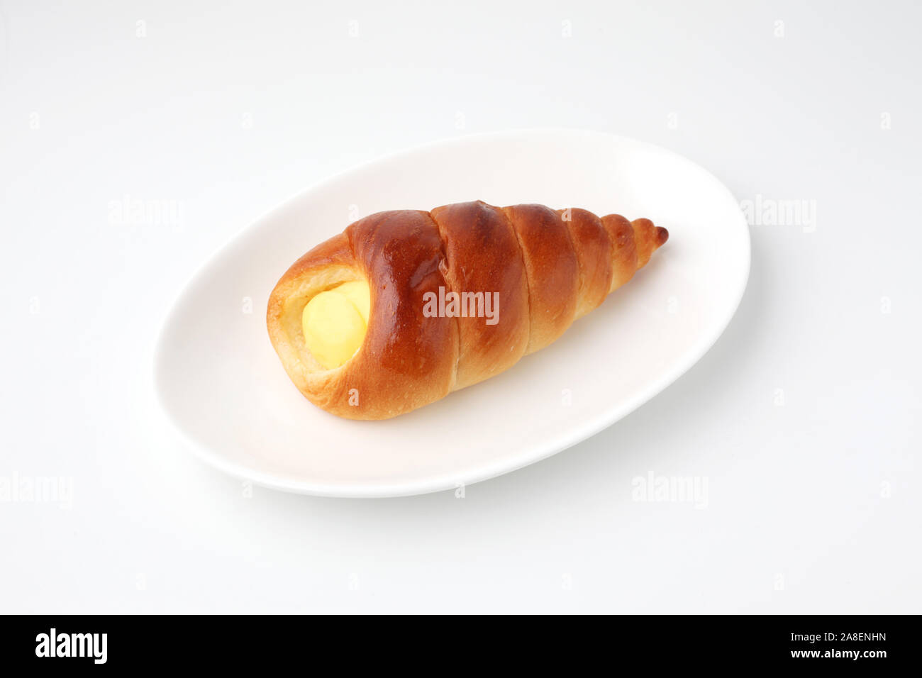 cream cornet roll bread on plate isolated on white background Stock ...