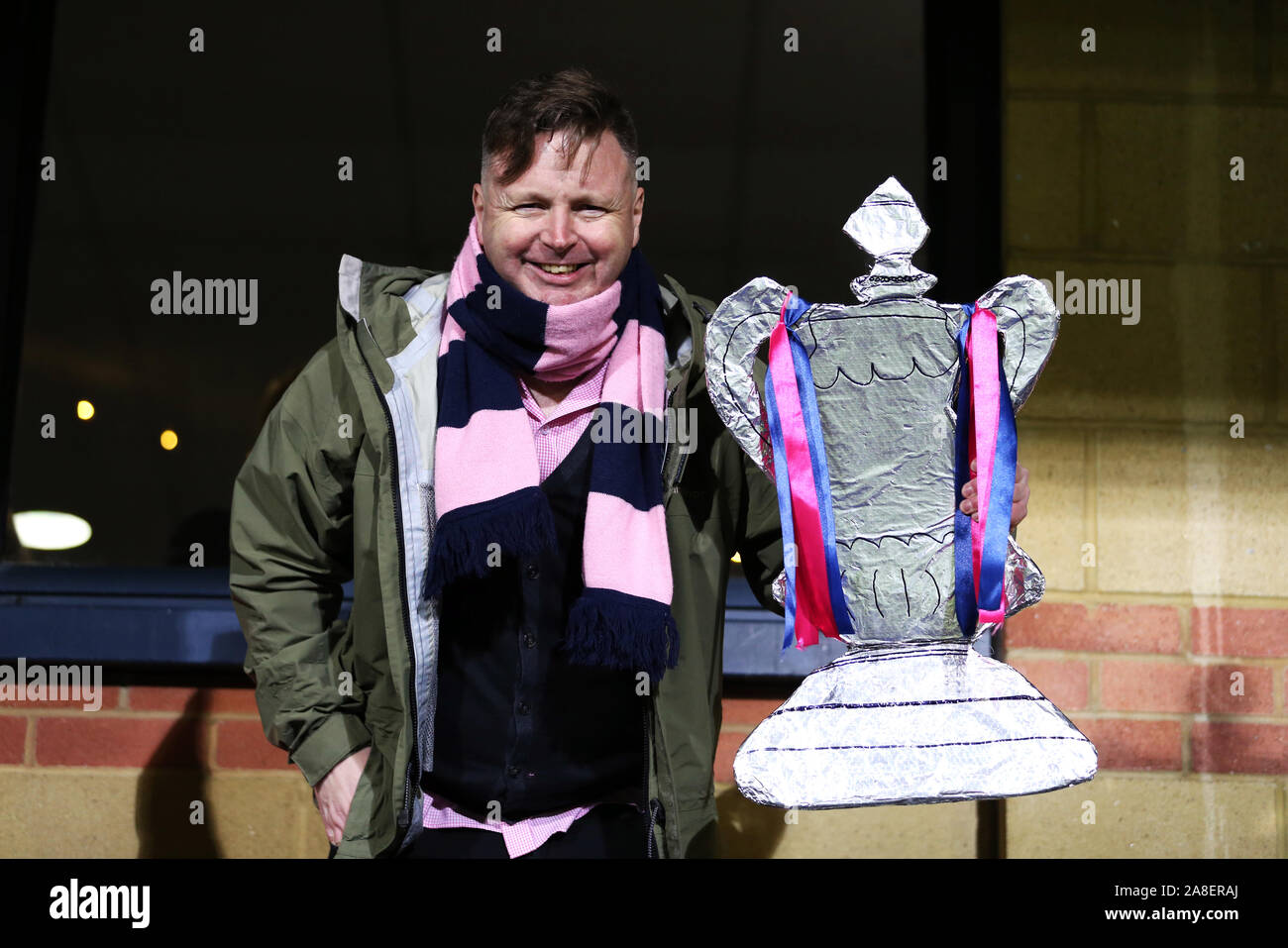 A Dulwich Hamlet fan holds up a replica FA Cup trophy before the FA Cup ...