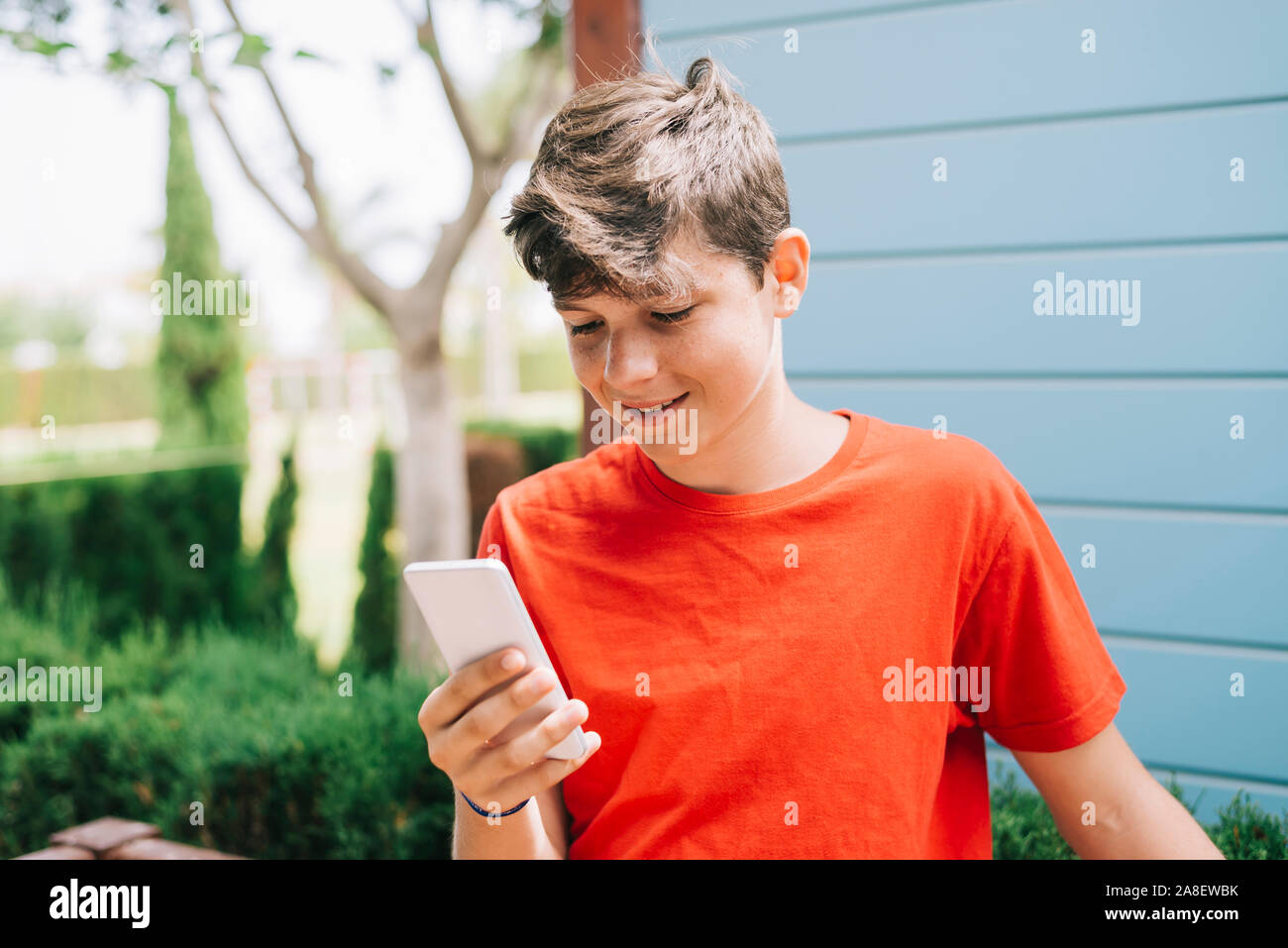 Profile of a happy guy texting on a smart phone Stock Photo - Alamy